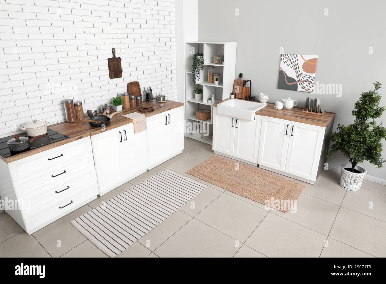 Kitchen counters with utensils and shelving unit in interior of kitchen ...