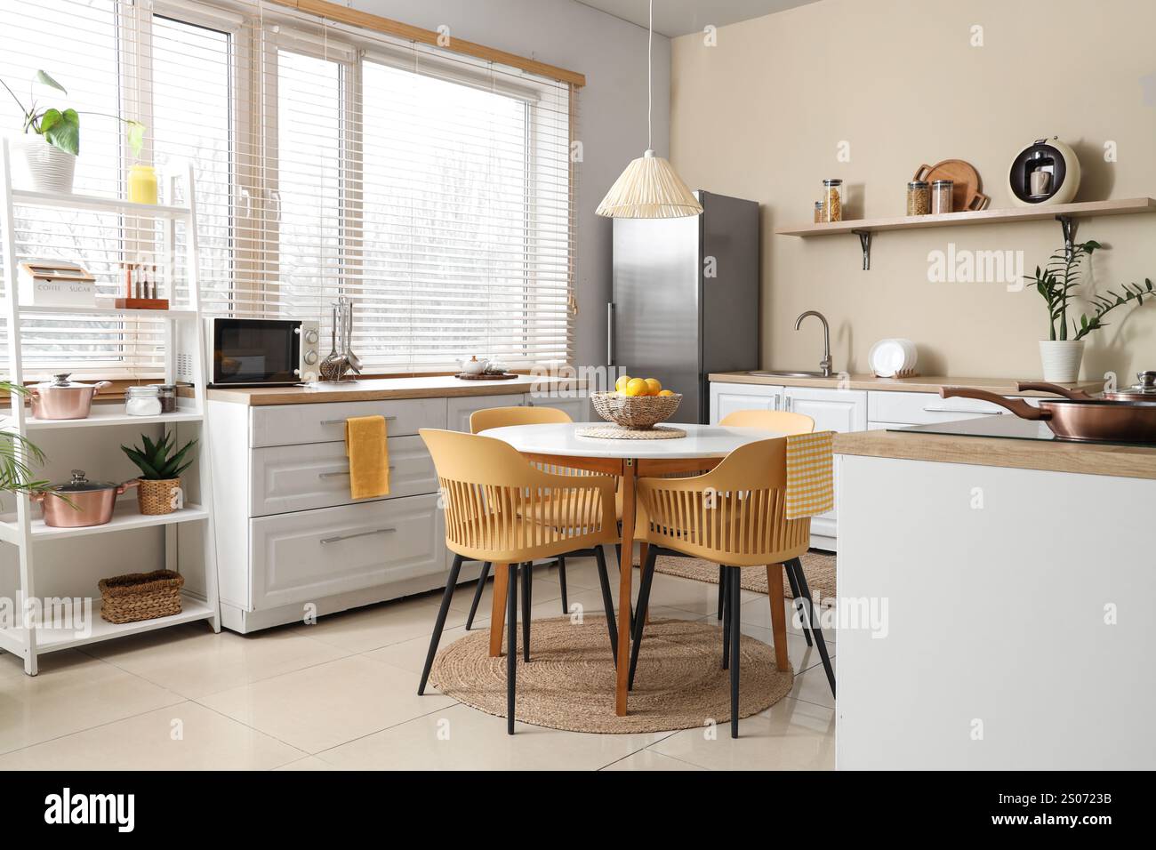 Interior of kitchen with dining table, counters and shelf unit Stock ...