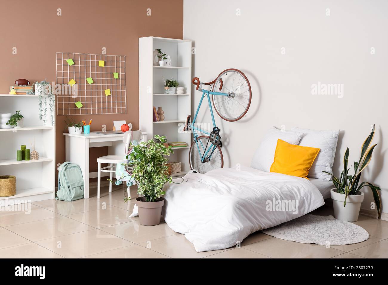 Interior of student's room with bed, shelf units and table Stock Photo ...