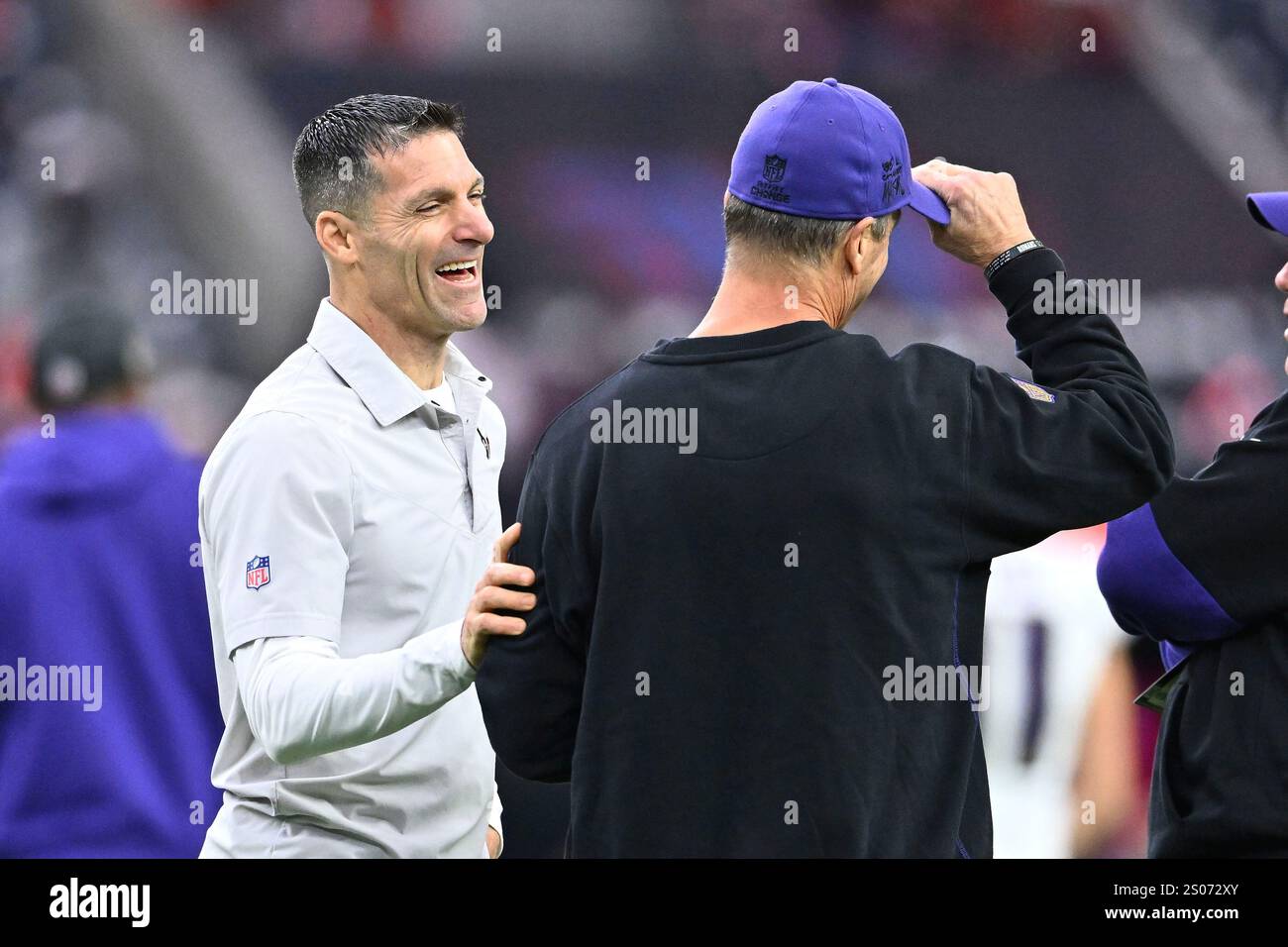 Houston Texans general manager Nick Caserio, left, talks with Baltimore ...