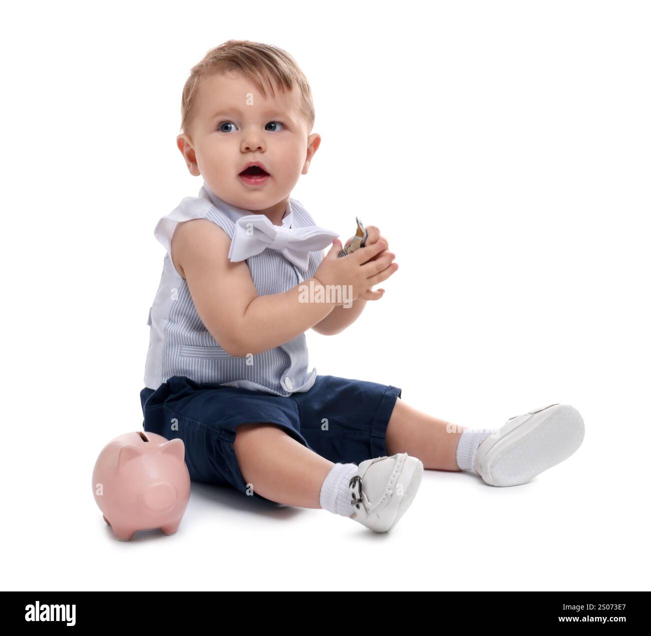 Little baby with money and piggybank on white background Stock Photo ...