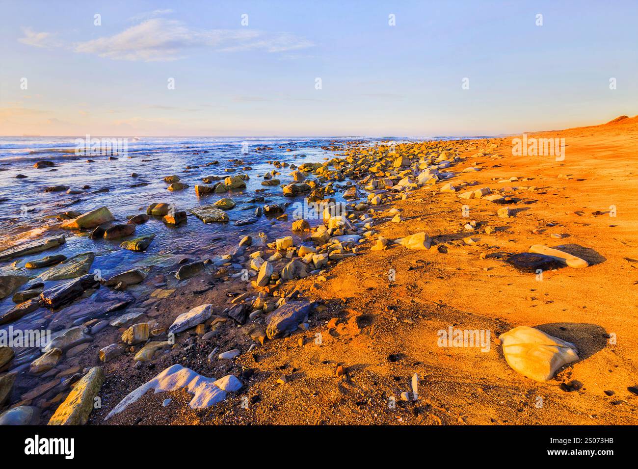 Soft light of rising sun of rocks and boulders of Hams beach in Pacific ...