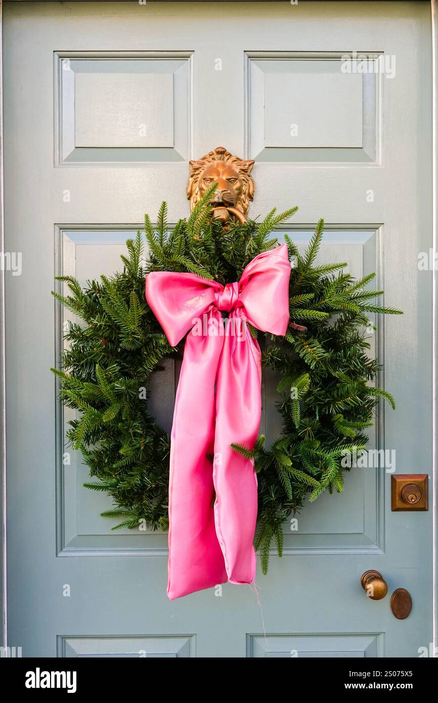 A Christmas wreath with a pink bow decorates a door of the Dothage ...
