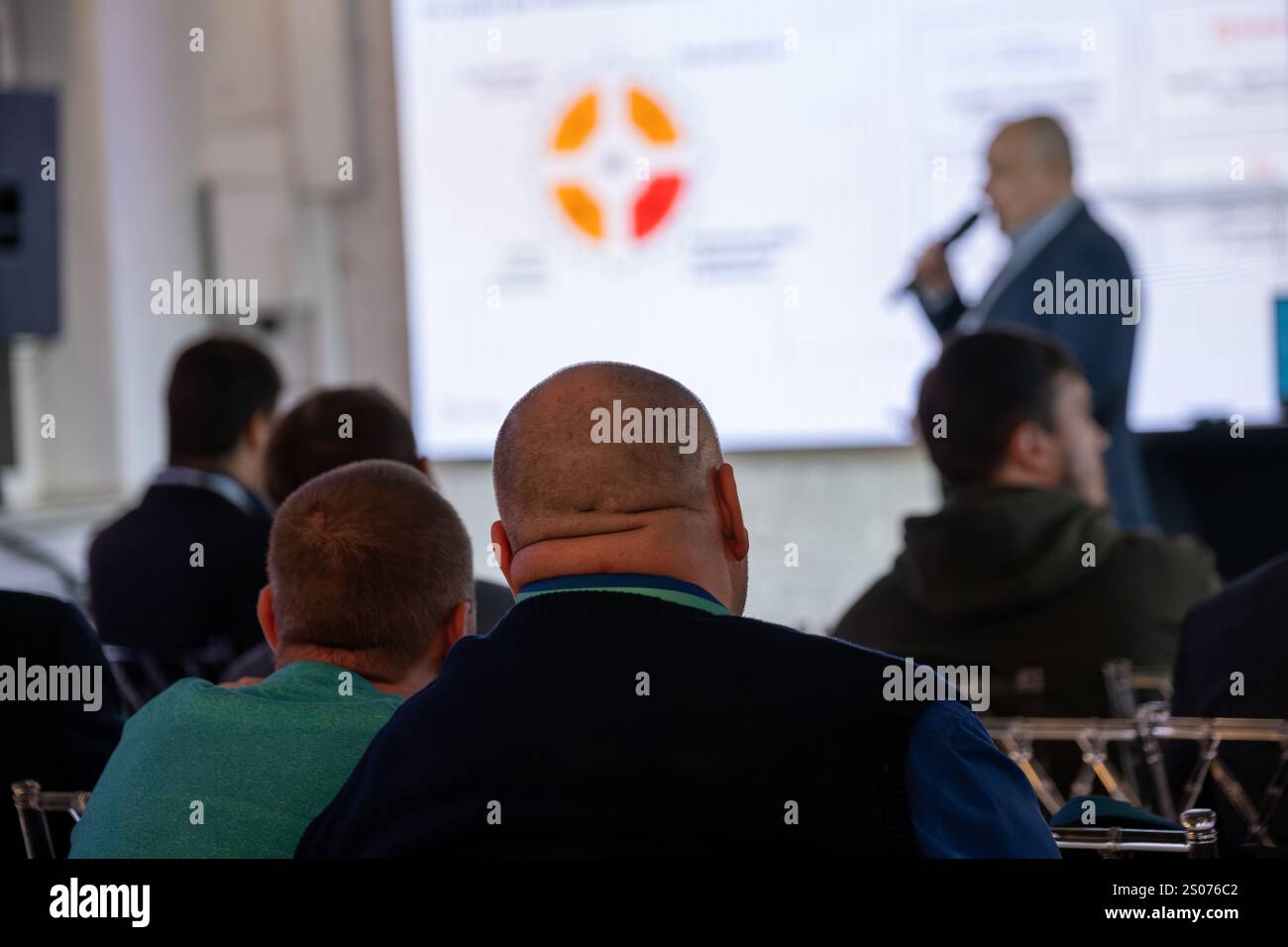 Audience engaged during business presentation as speaker presents with ...
