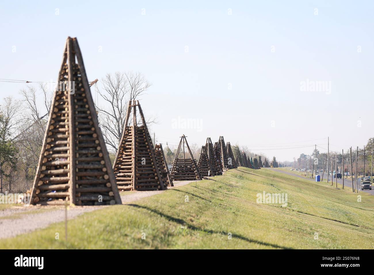 A row of bonfires are displayed throughout the Mississippi River levee ...