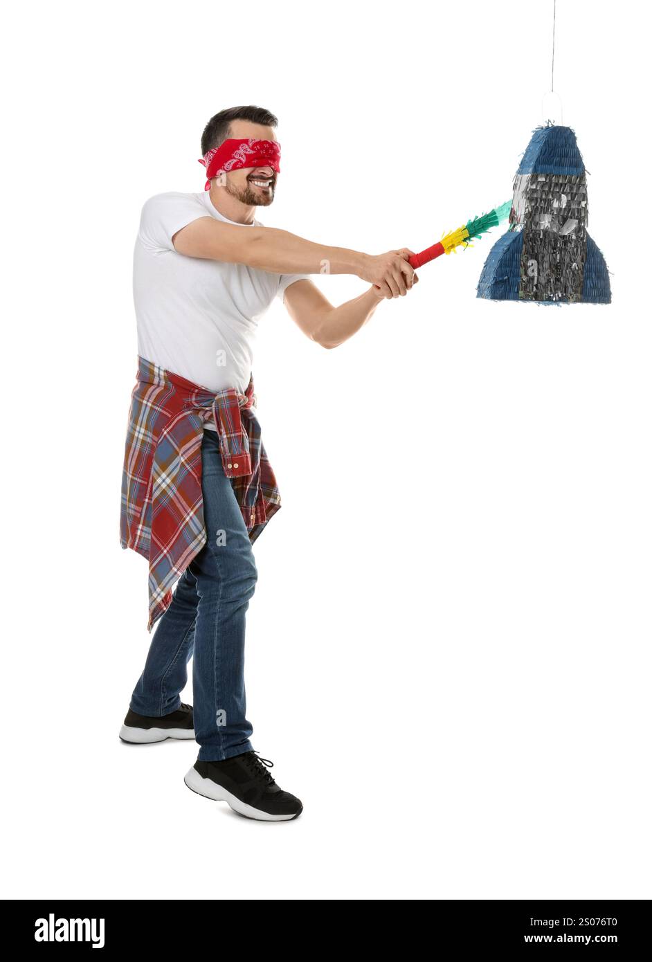 Blindfolded man hitting rocket shaped pinata with stick on white ...