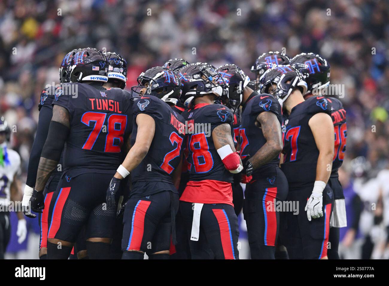 Houston Texans huddle up while taking on the Baltimore Ravens, in an ...
