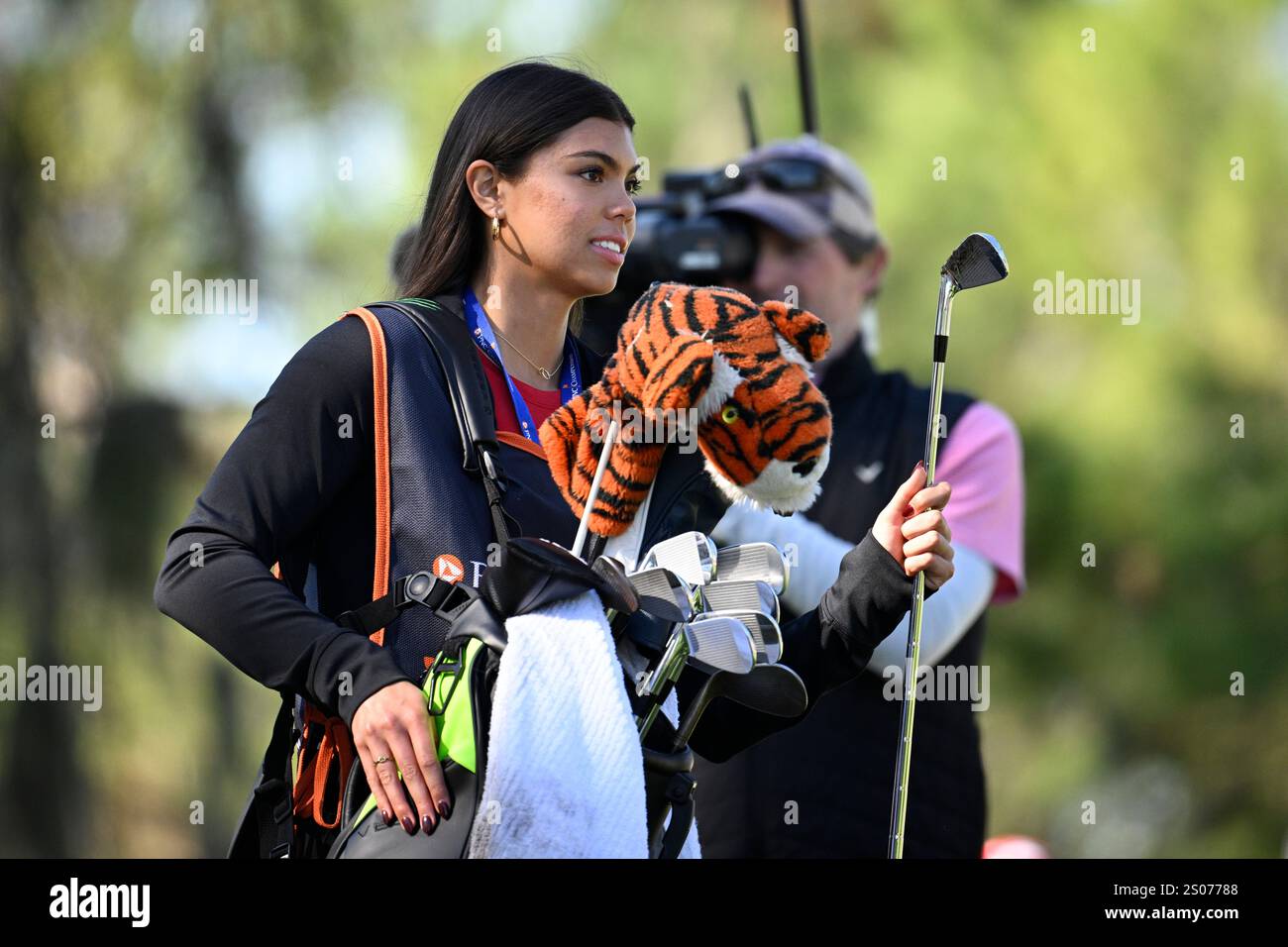 Sam Woods caddies for her father Tiger Woods while walking to the ...