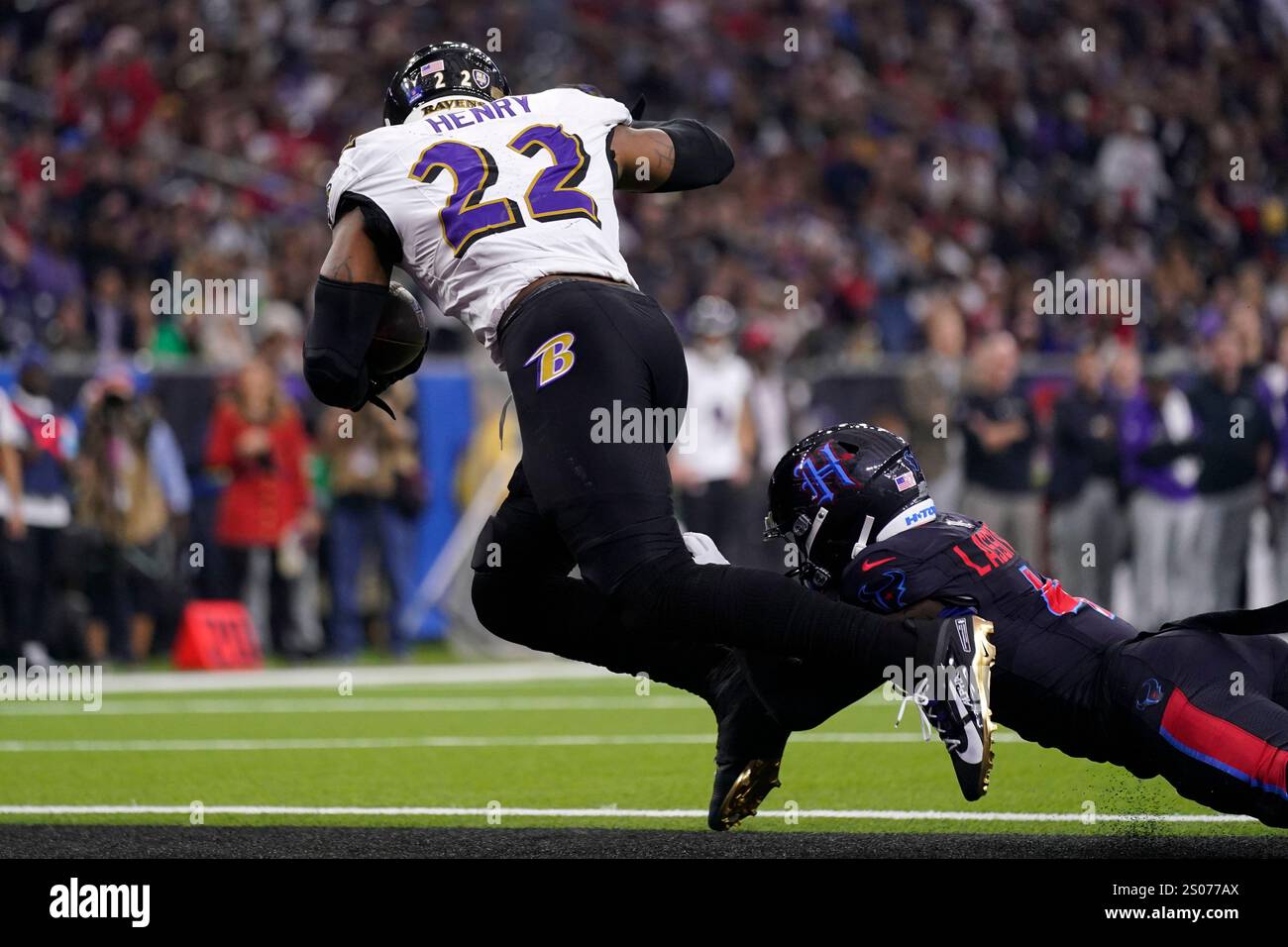 Baltimore Ravens running back Derrick Henry (22) is tackled by Houston ...