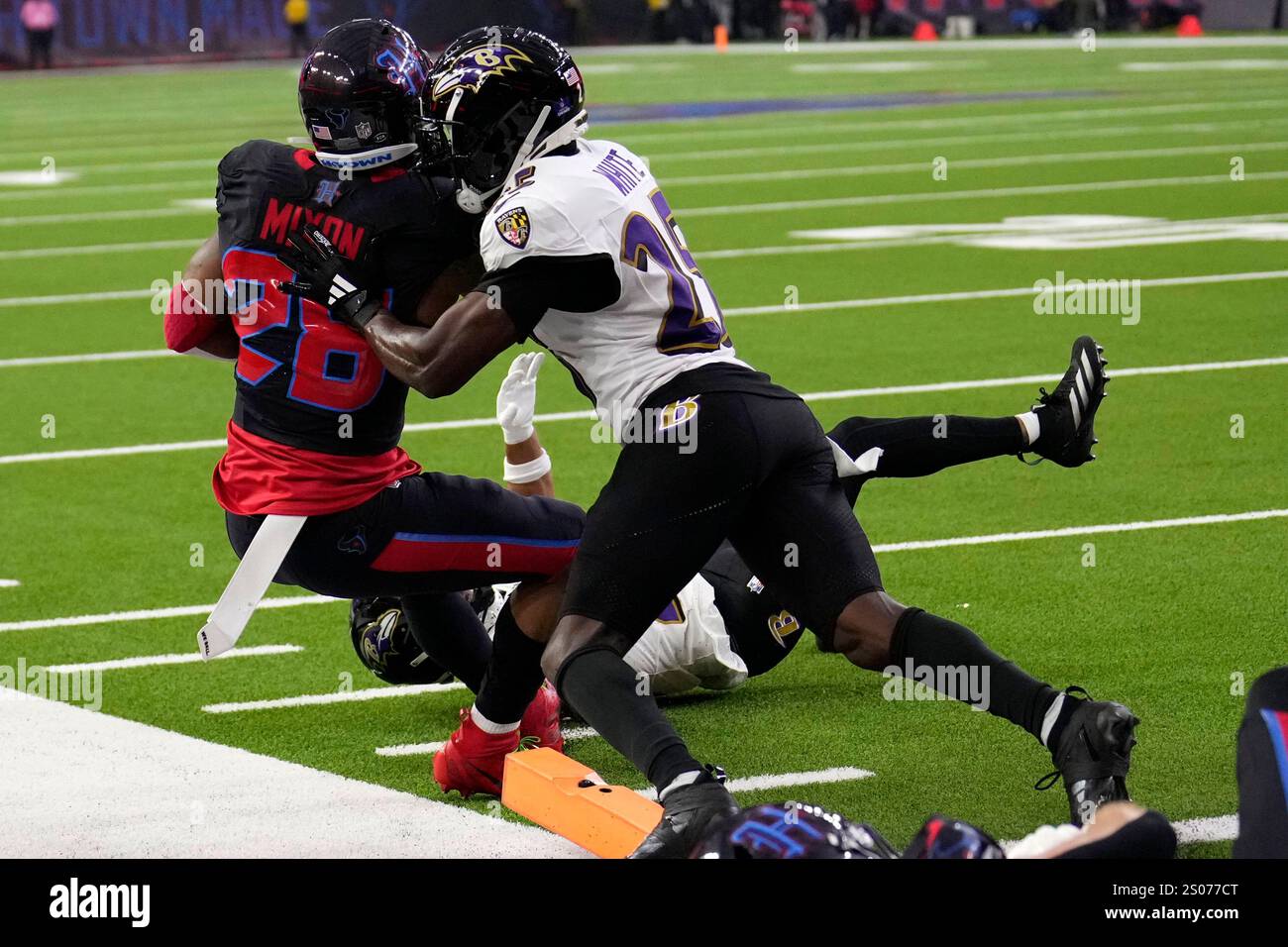 Houston Texans running back Joe Mixon (28) is tackled by Baltimore ...