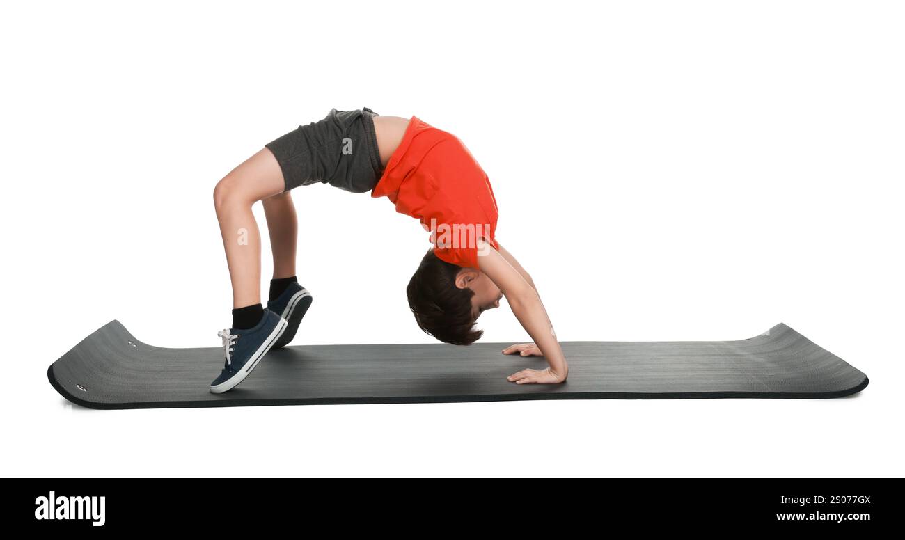 Boy exercising on fitness mat against white background. Sport activity ...