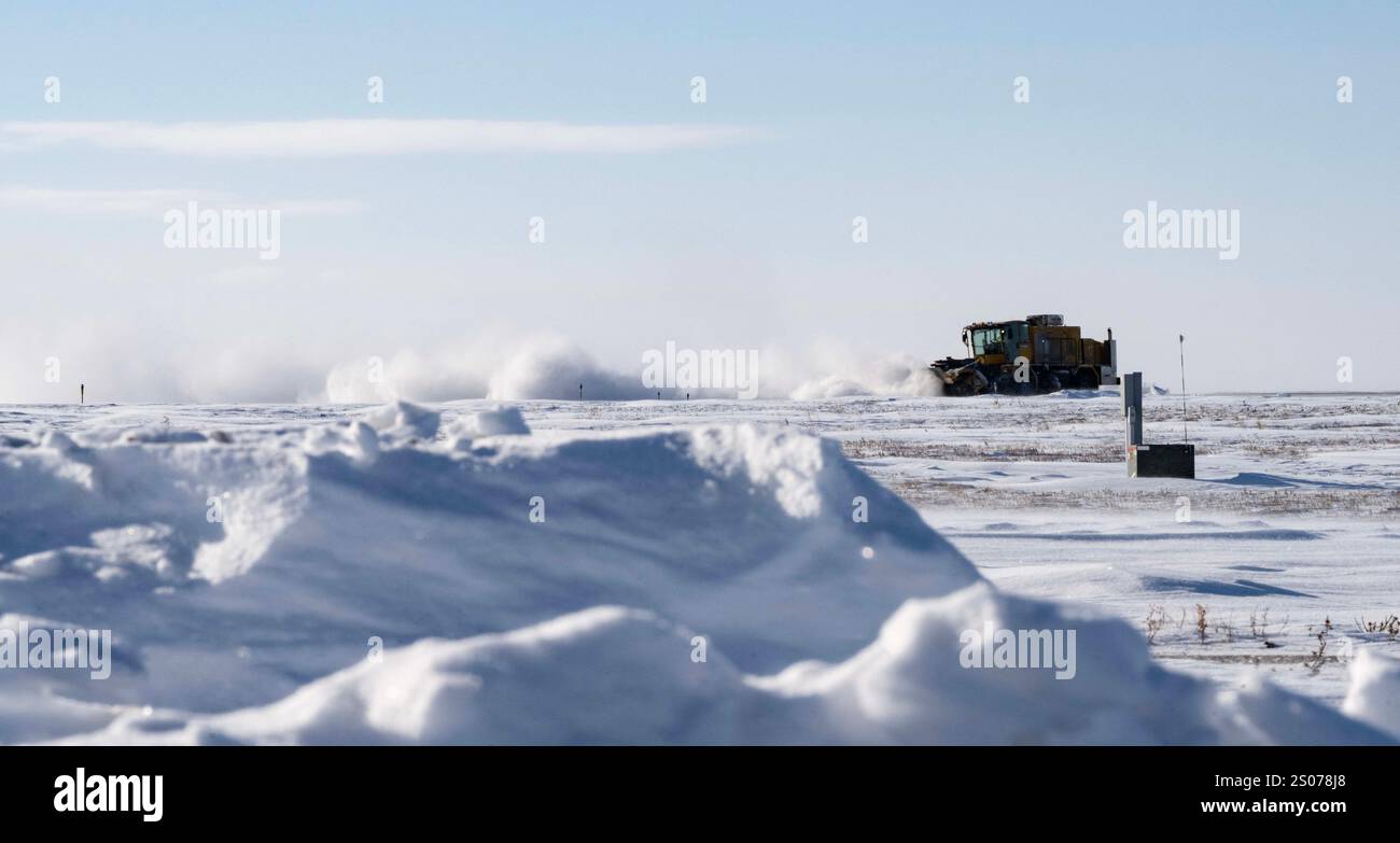 An Airman assigned to the 5th Civil Engineer Squadron plows snow after ...