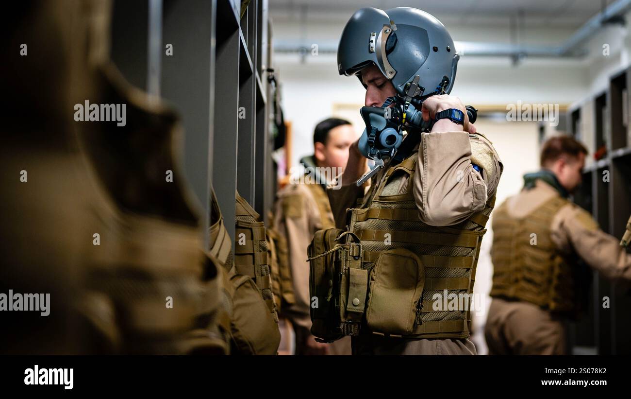 A U.S. Airman assigned to the 69th Expeditionary Bomb Squadron dons ...