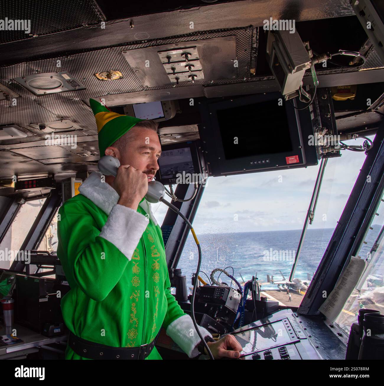 241224-N-GC571-1014 SOUTH CHINA SEA (Dec. 24, 2024) Cmdr. Jeffrey Sweitzer, air boss aboard the ...