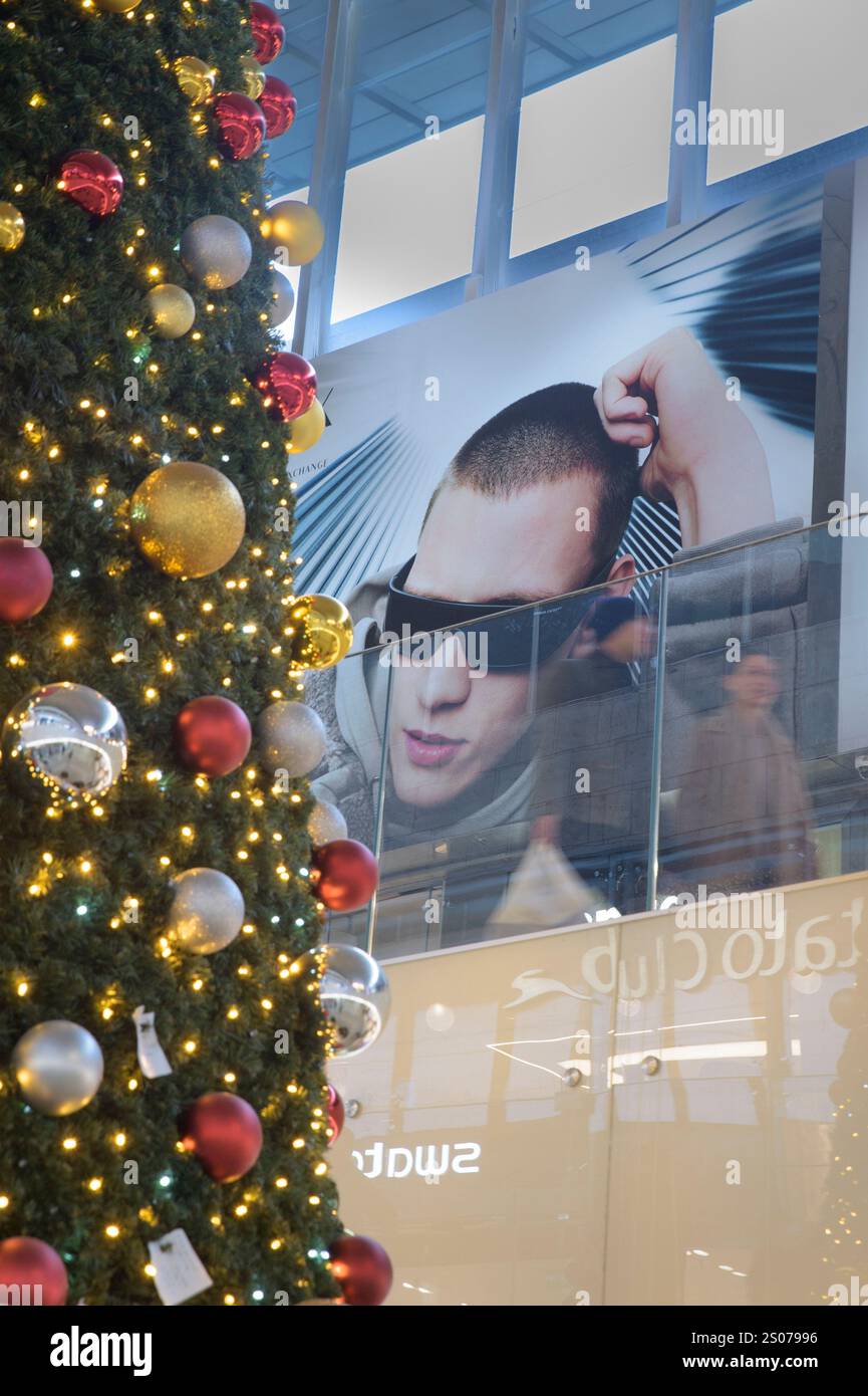 Rome, Italy. 24th Dec, 2024. At Termini station, a large poster depicts ...