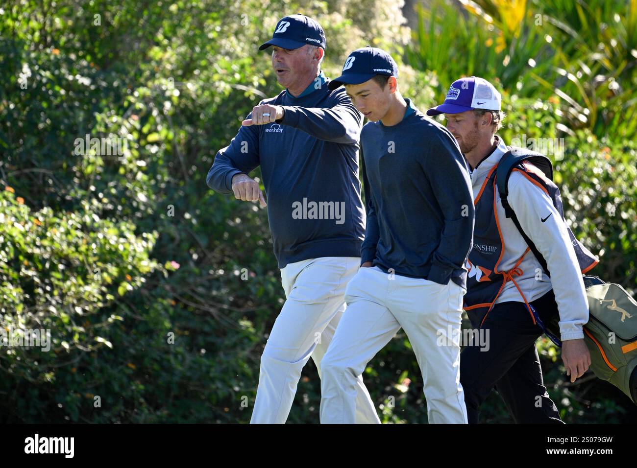 Matt Kuchar, left, and his son Carson Kuchar walk on the third hole ...