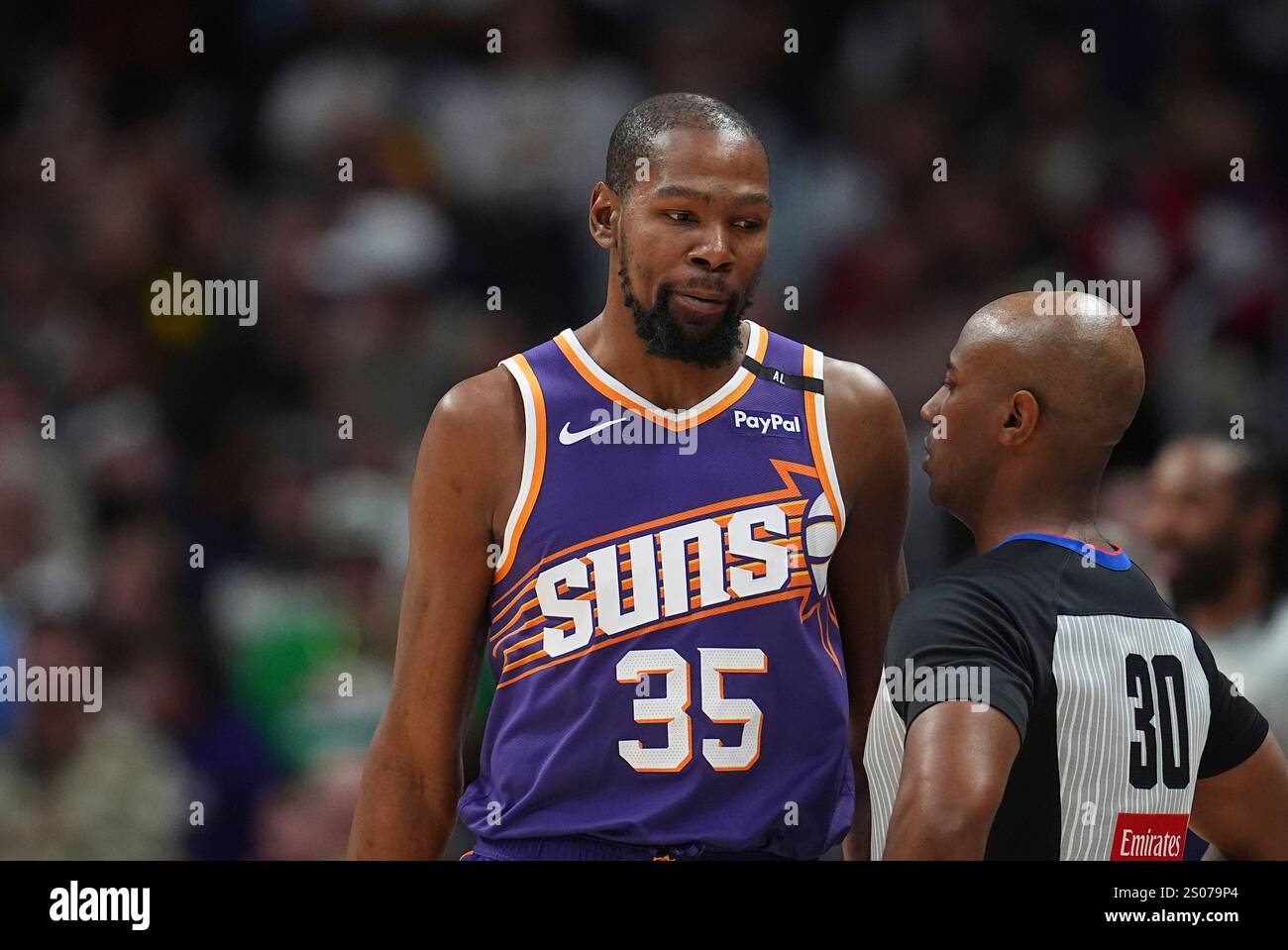 Phoenix Suns forward Kevin Durant (35) confers with referee John Butler ...