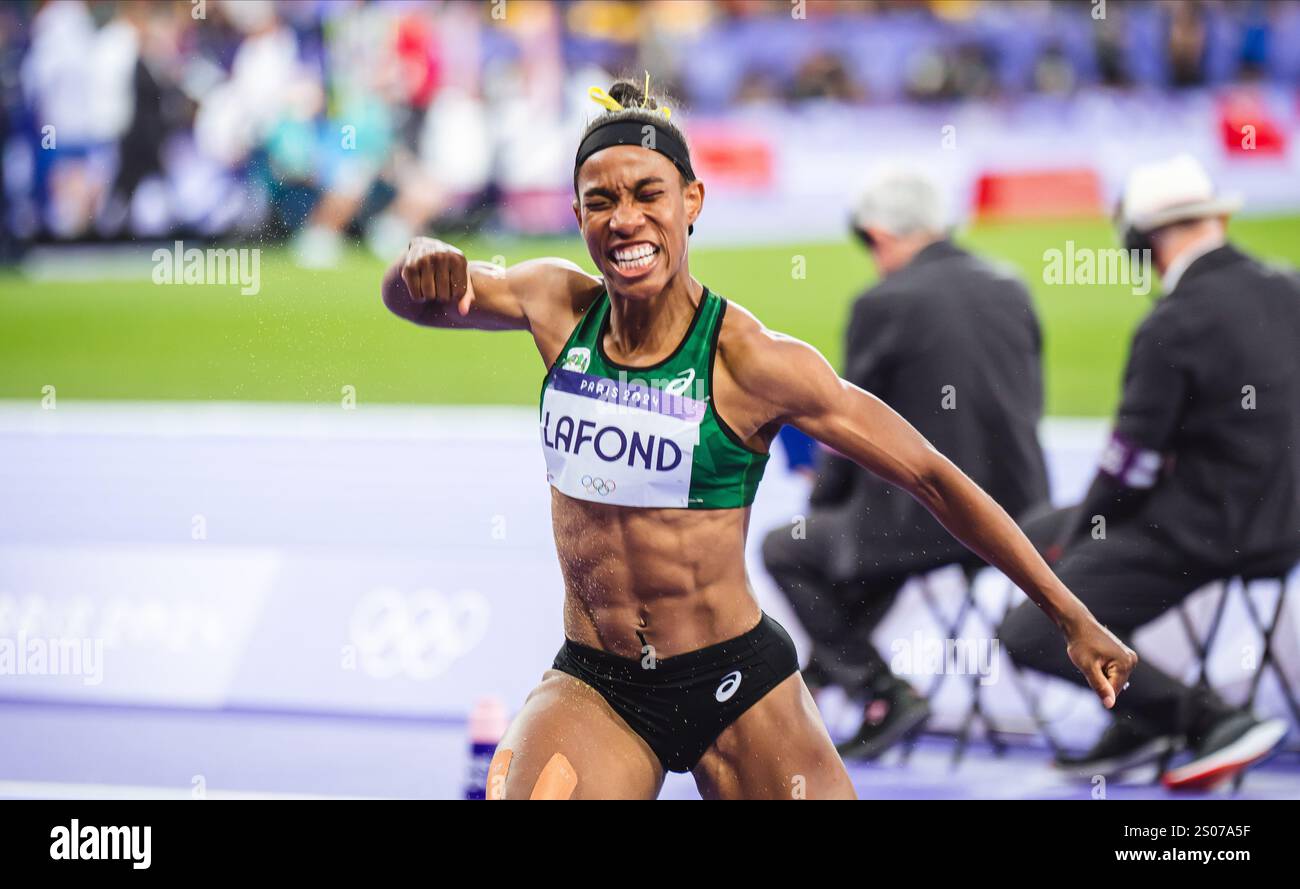 Thea LaFond celebrating her medal with her country's flag at the Paris ...