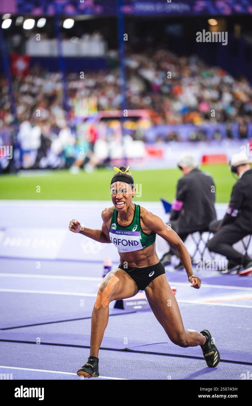Thea LaFond celebrating her medal with her country's flag at the Paris ...