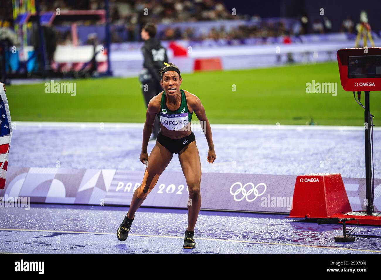 Thea LaFond celebrating her medal with her country's flag at the Paris ...