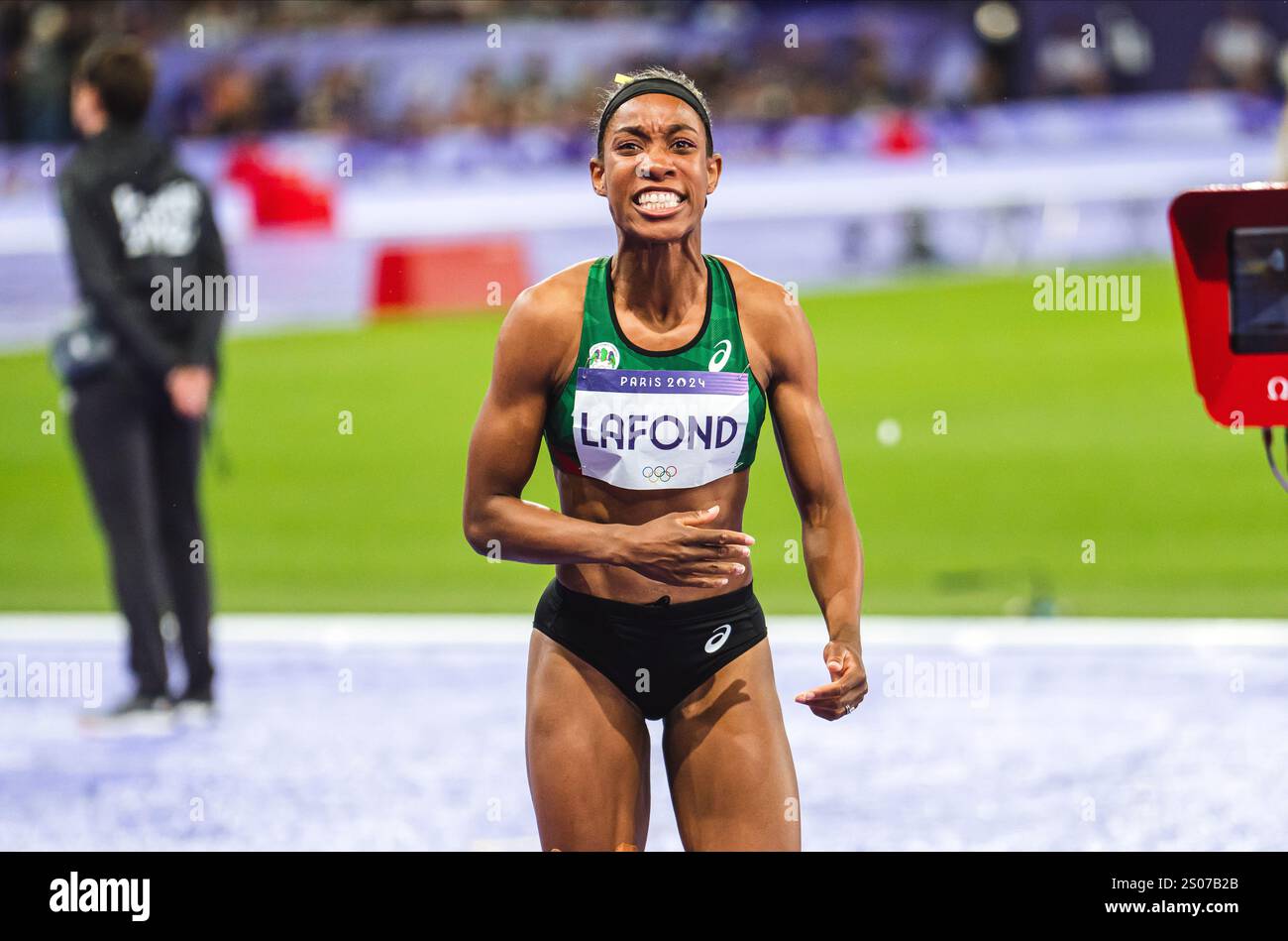 Thea LaFond celebrating her medal with her country's flag at the Paris ...