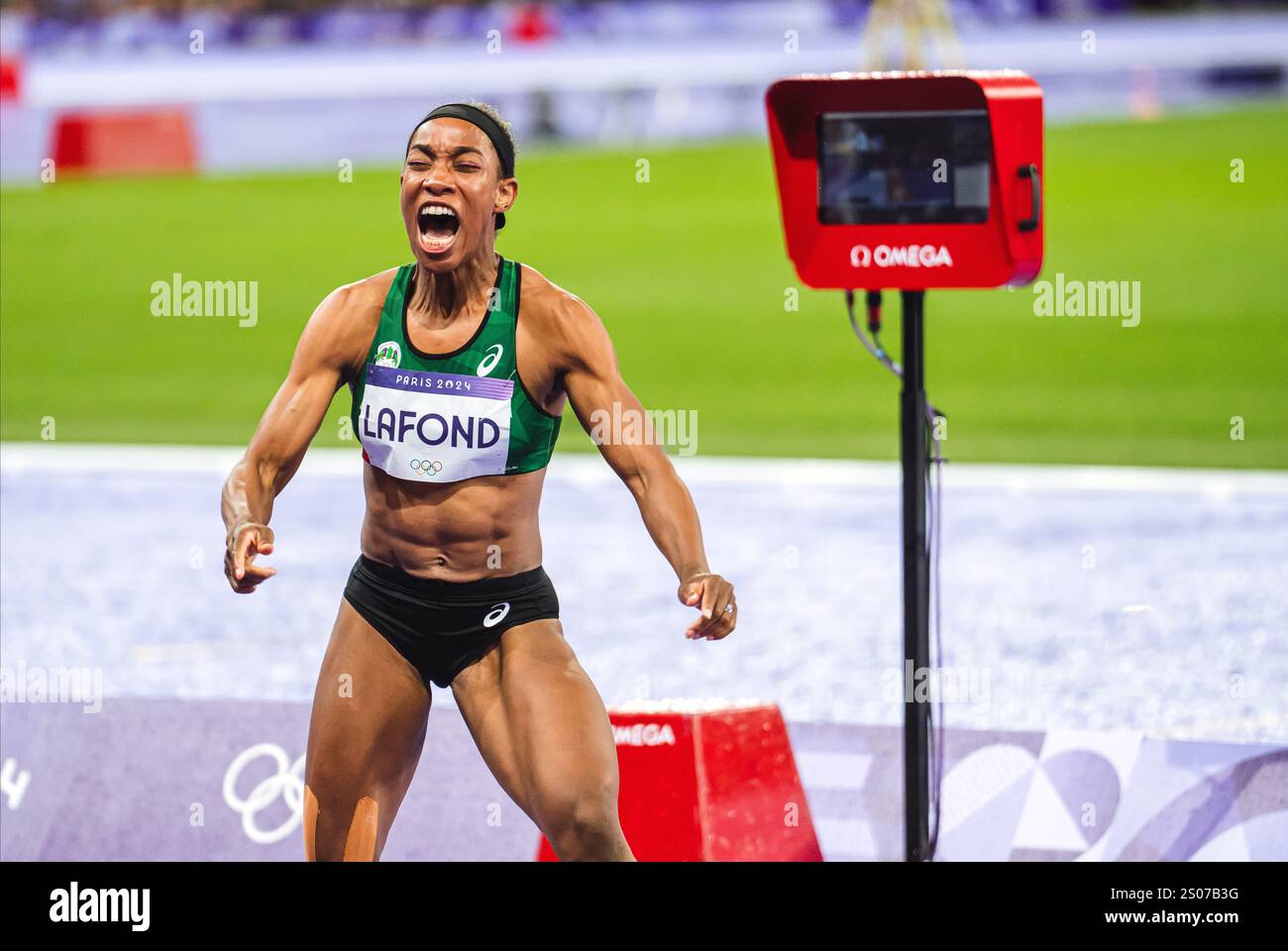 Thea LaFond celebrating her medal with her country's flag at the Paris ...