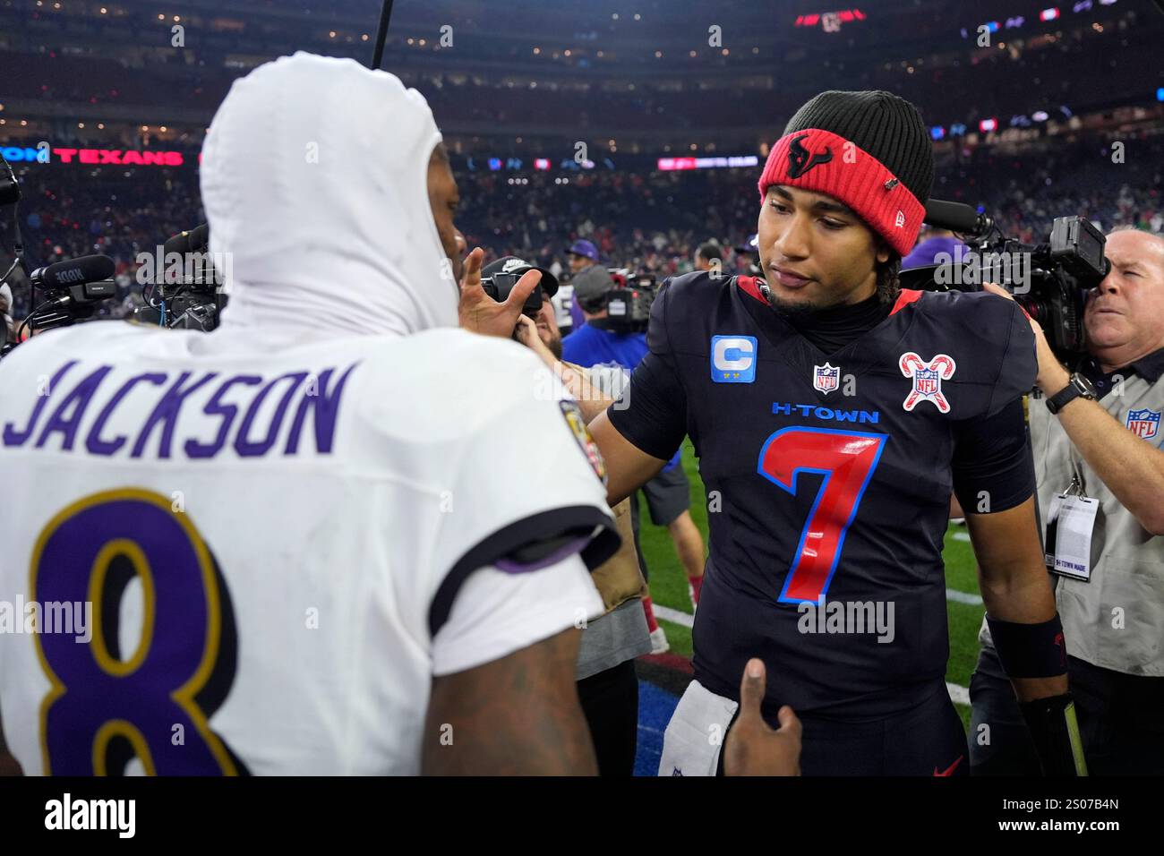 Houston Texans quarterback C.J. Stroud (7) talks with Baltimore Ravens ...