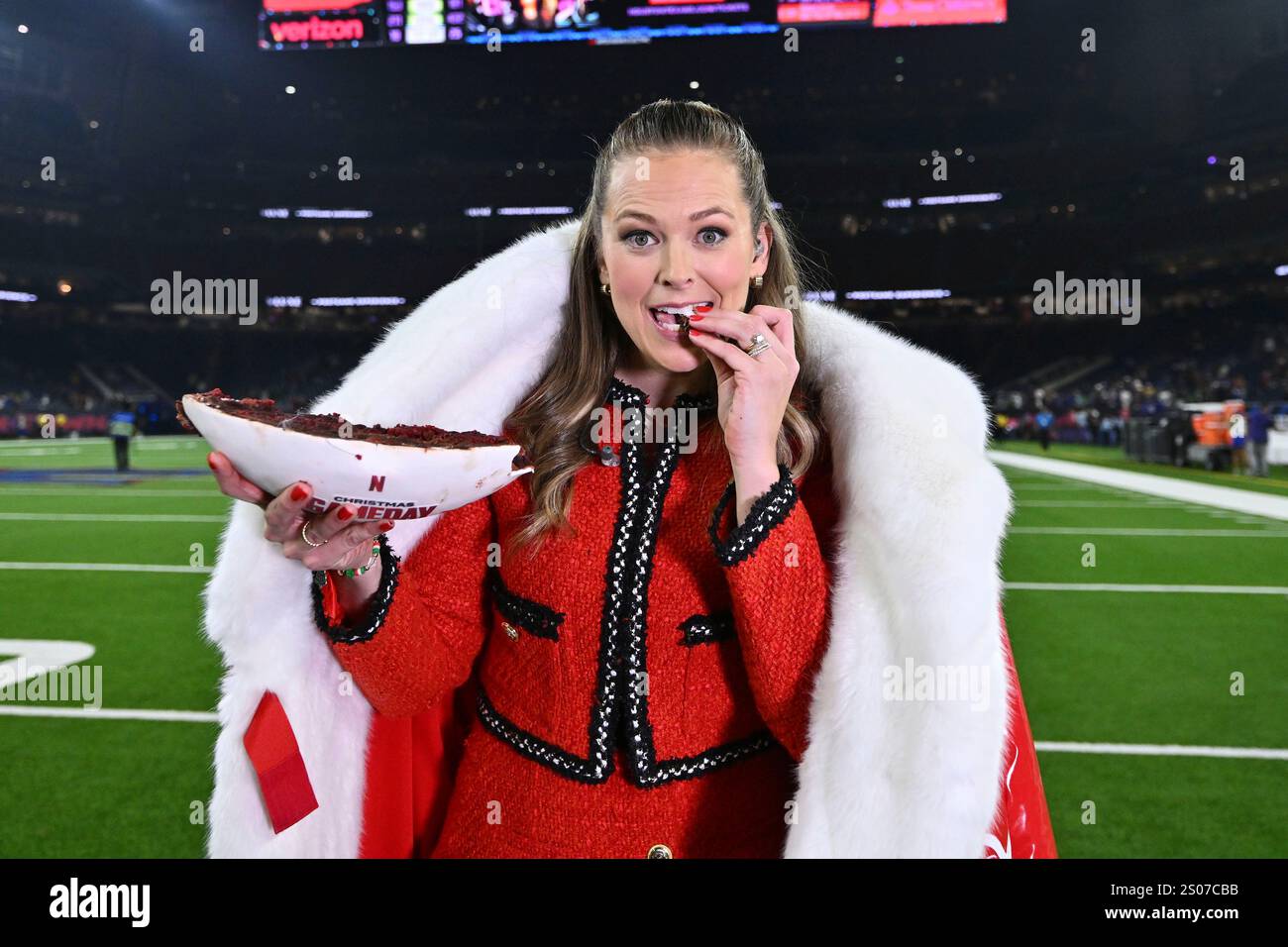 Netflix reporter Jamie Erdahl poses for a picture while taking a bite ...