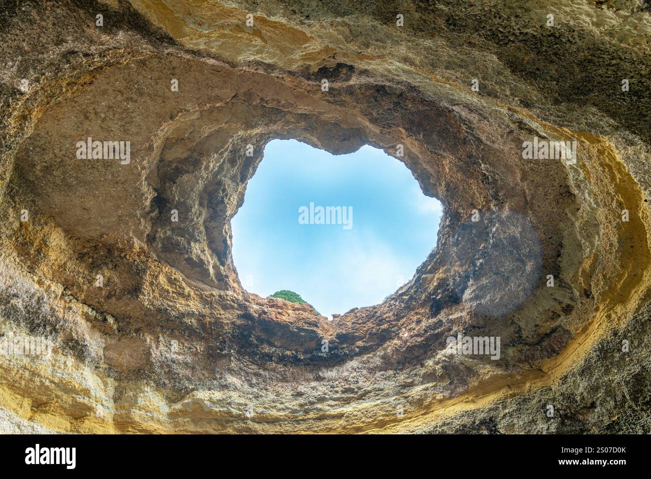 A heart-shaped skylight illuminates the interior of Benagil Cave, one ...