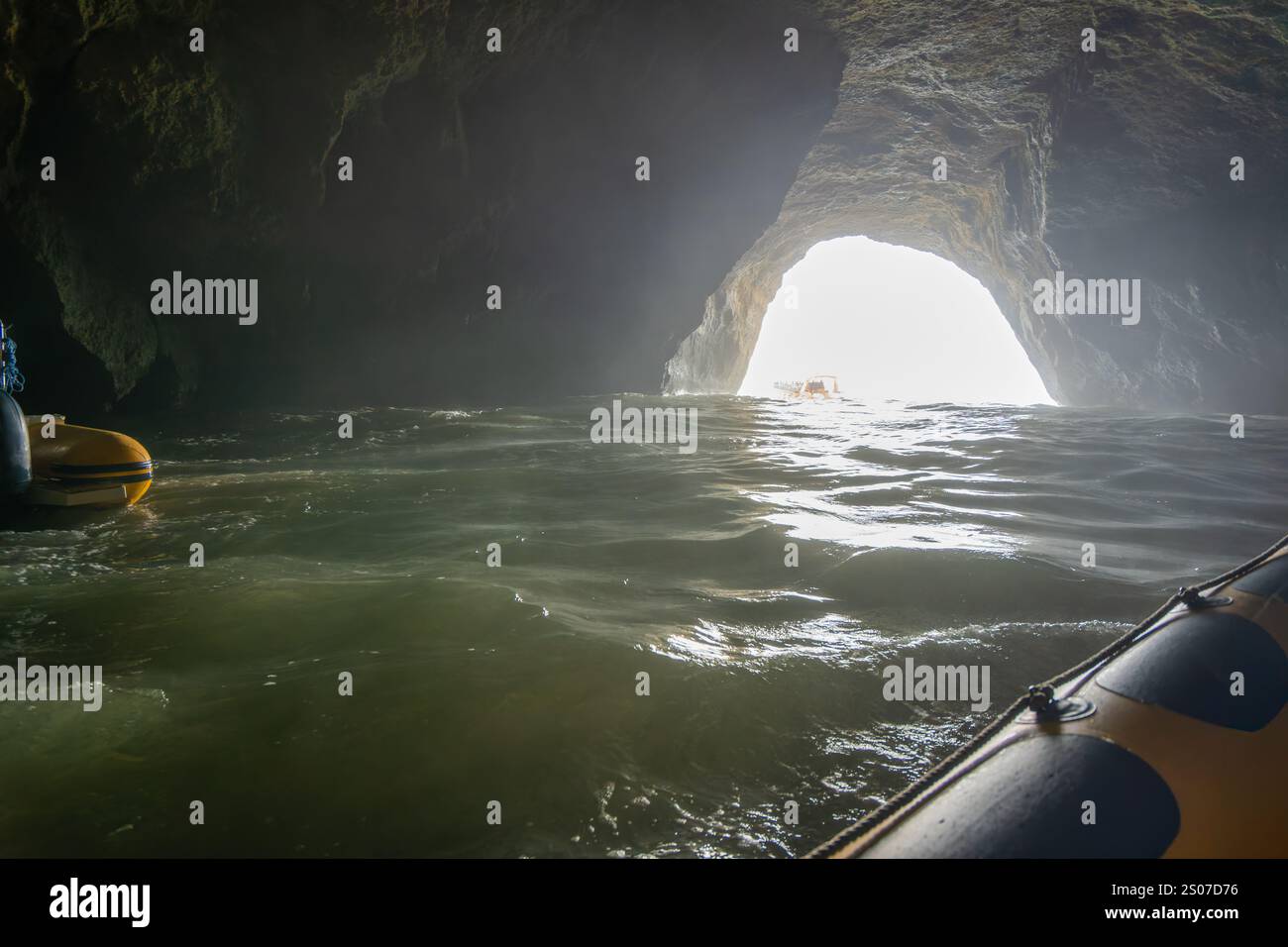 A breathtaking view of a natural sea cave carved into the dramatic ...