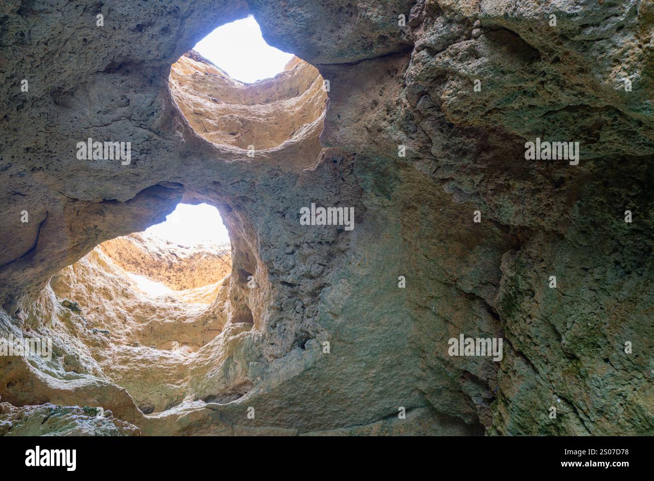 A stunning view of sunlight streaming through a natural sea cave ...