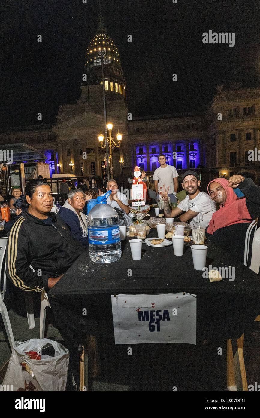 Participants in the Christmas Eve dinner at one of the many tables set ...