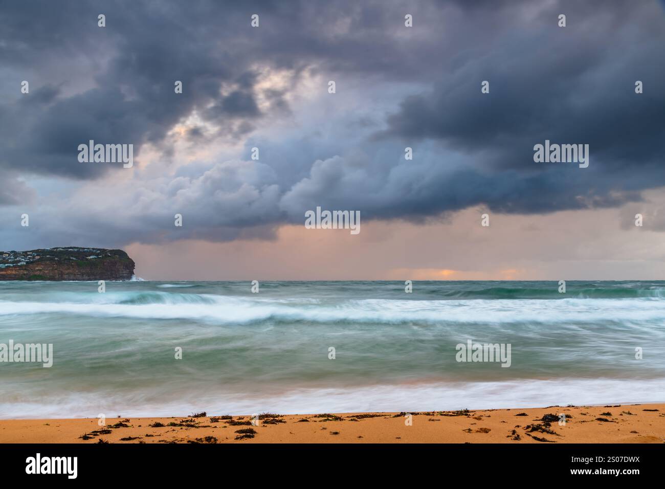 Rainy day sunrise with overcast sky and good sized choppy waves at ...