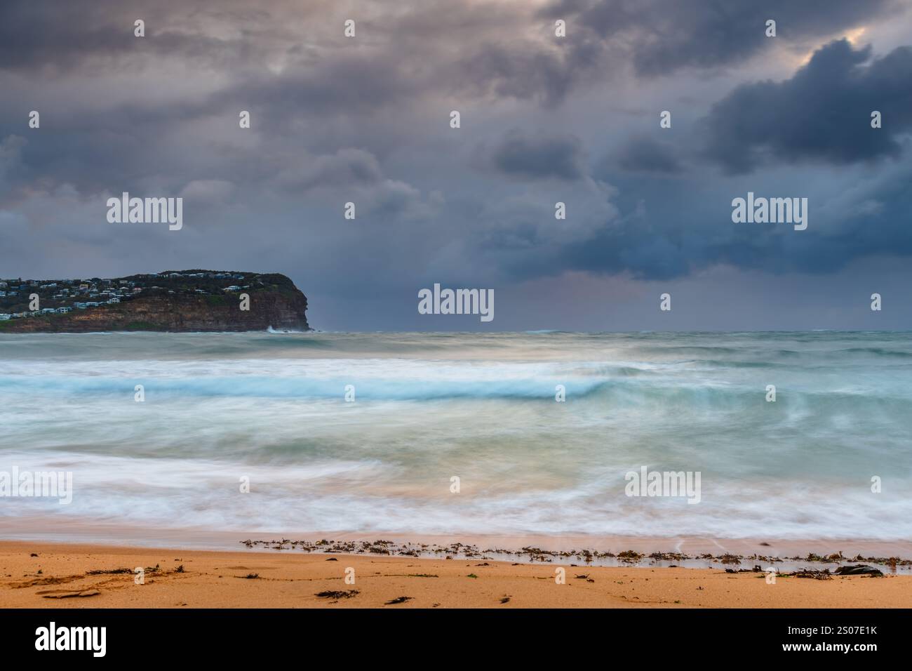 Rainy day sunrise with overcast sky and good sized choppy waves at ...