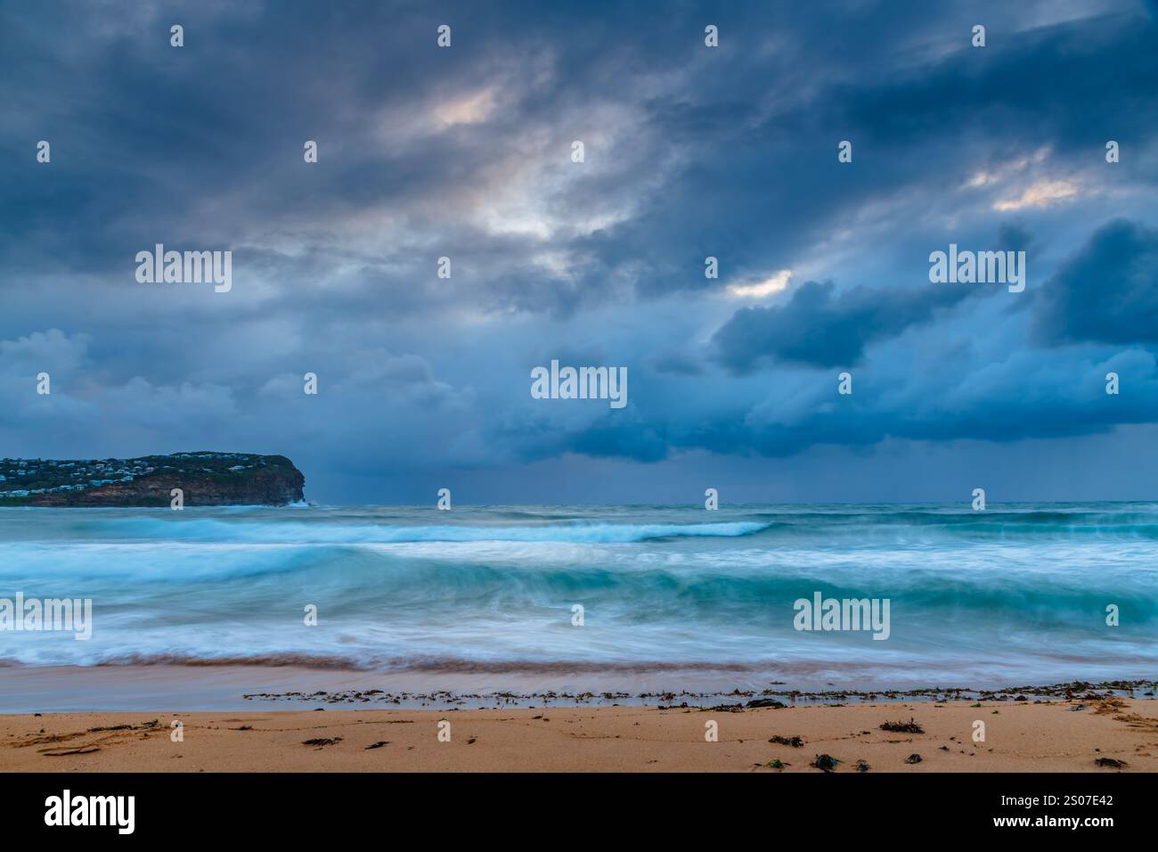 Rainy day sunrise with overcast sky and good sized choppy waves at ...