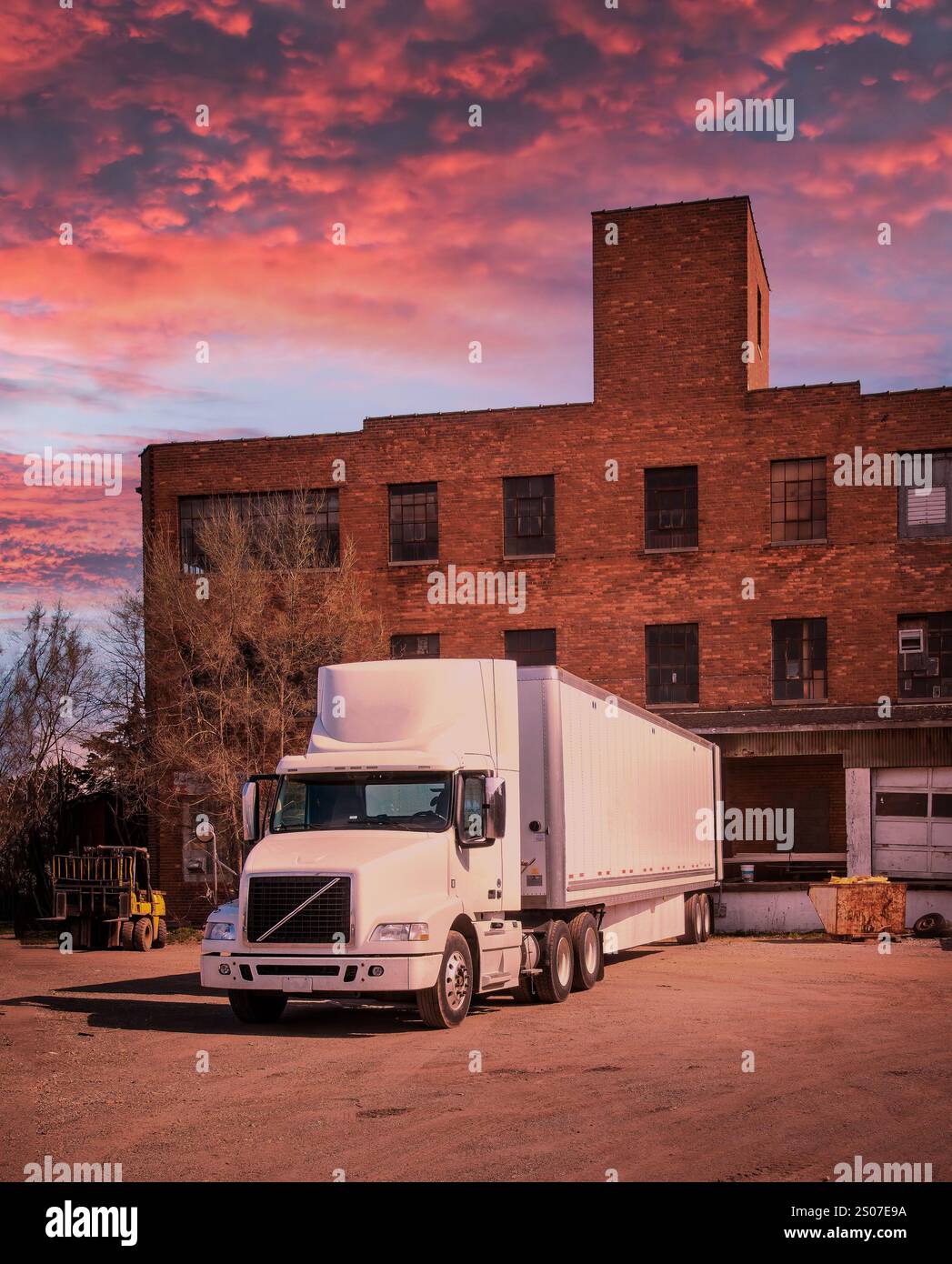 Long haul truck at loading dock for pick-up or delivery at dawn sunrise ...