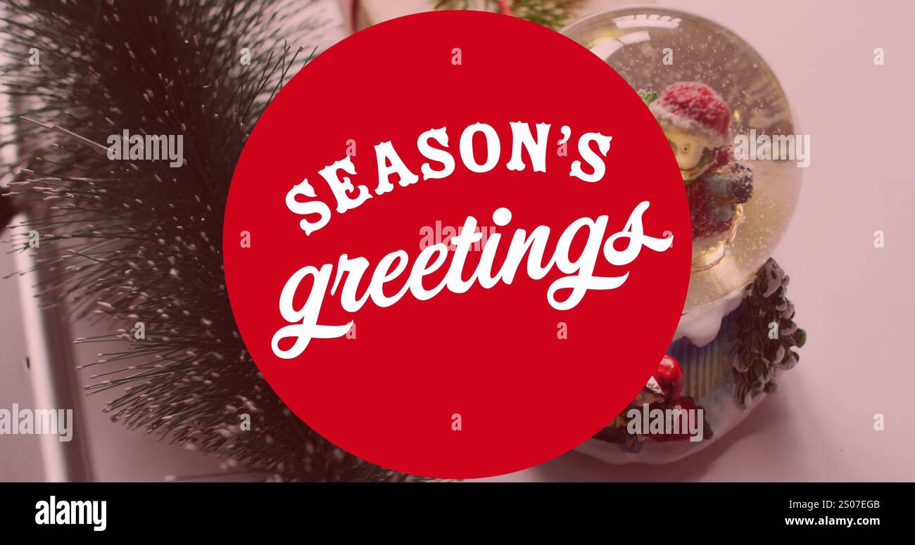 Image of christmas greetings text over christmas snow globe and ...