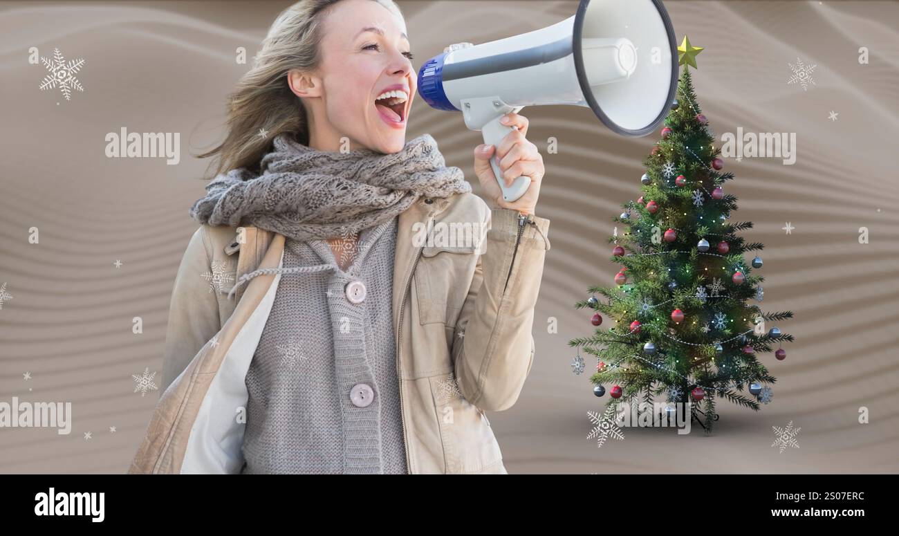 Image of caucasian woman with loudspeaker and christmas tree over snow ...