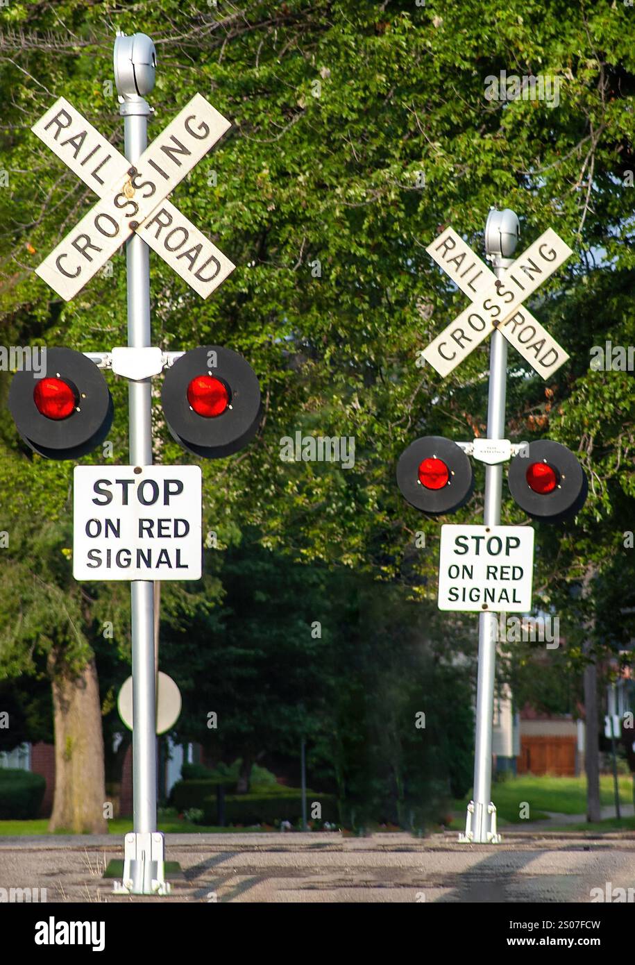 Multi Track railroad crossing red flashing signals Stock Photo - Alamy