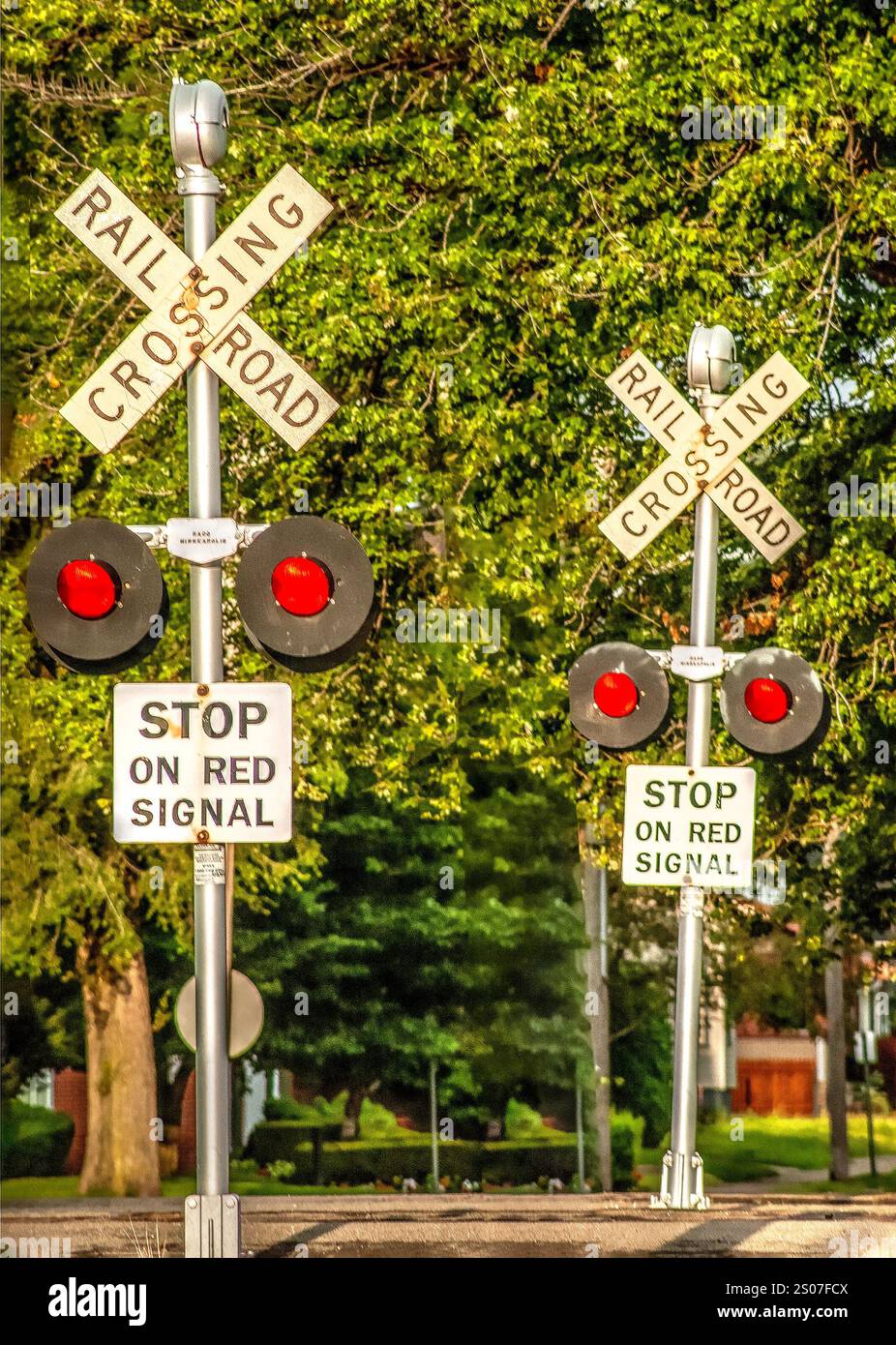 Multi Track railroad crossing red flashing signals Stock Photo - Alamy