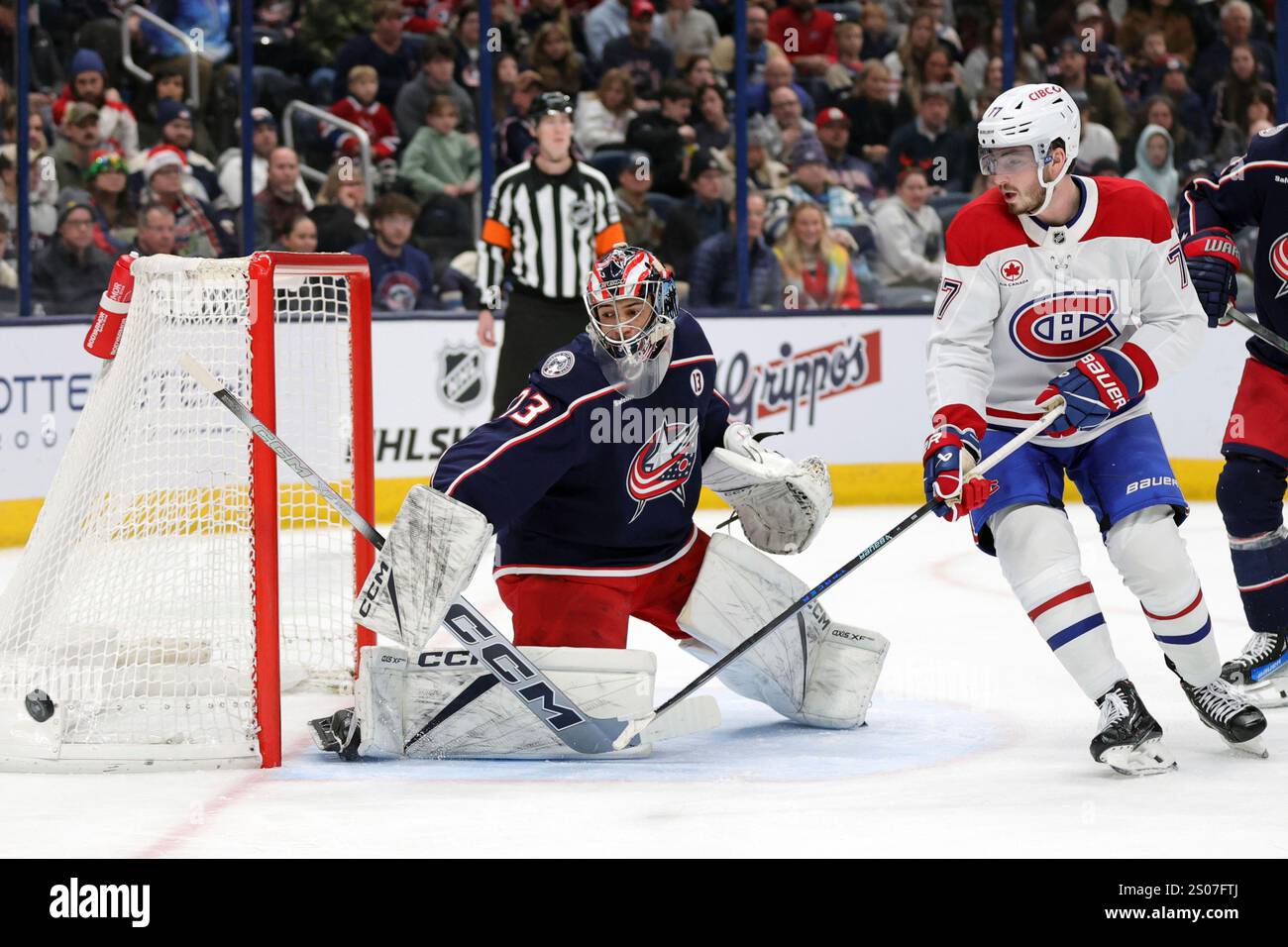 Columbus Blue Jackets goalie Jet Greaves, left, makes a save in front ...