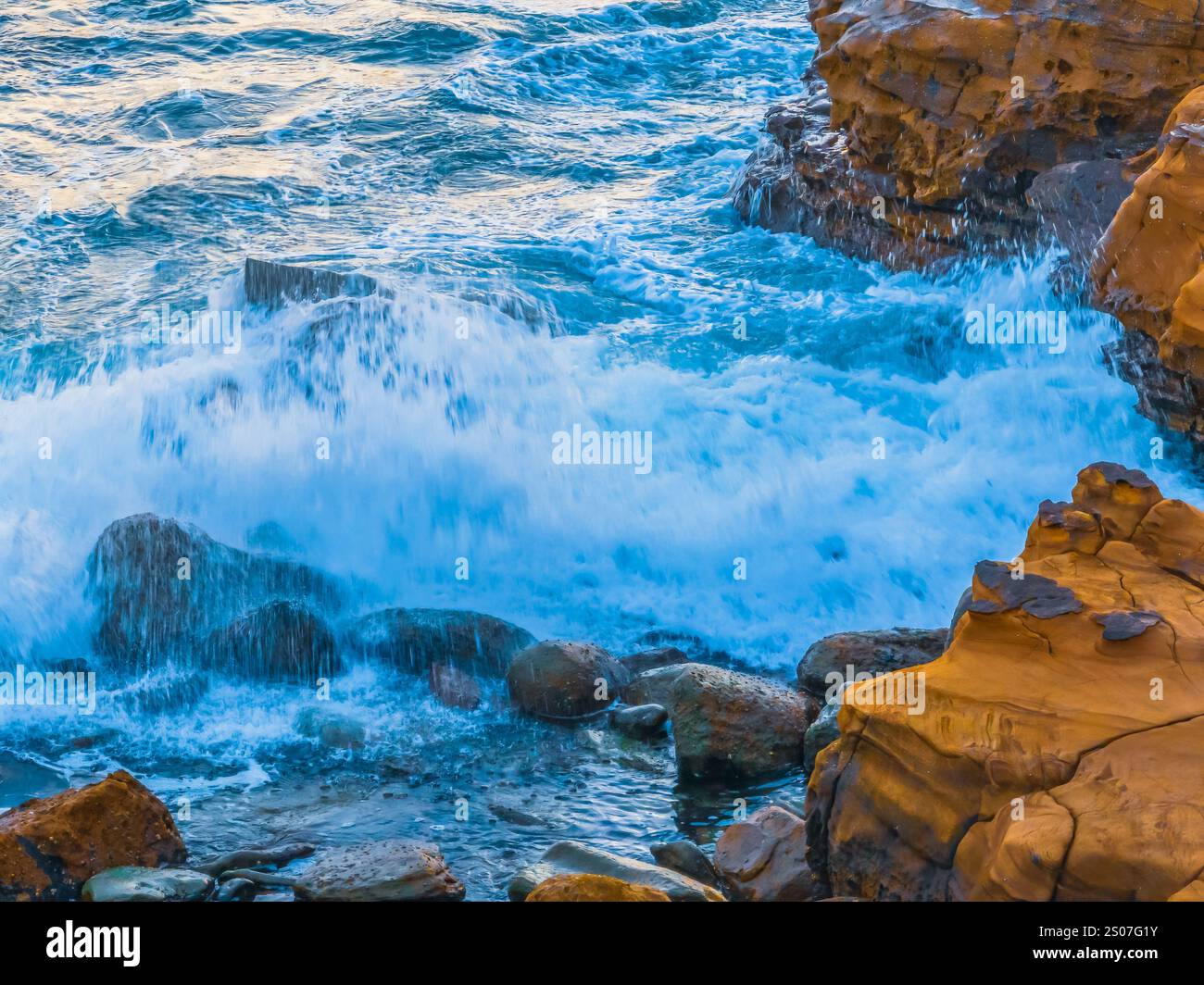 Top down over the sea and rocks in the early morning light at Avoca ...