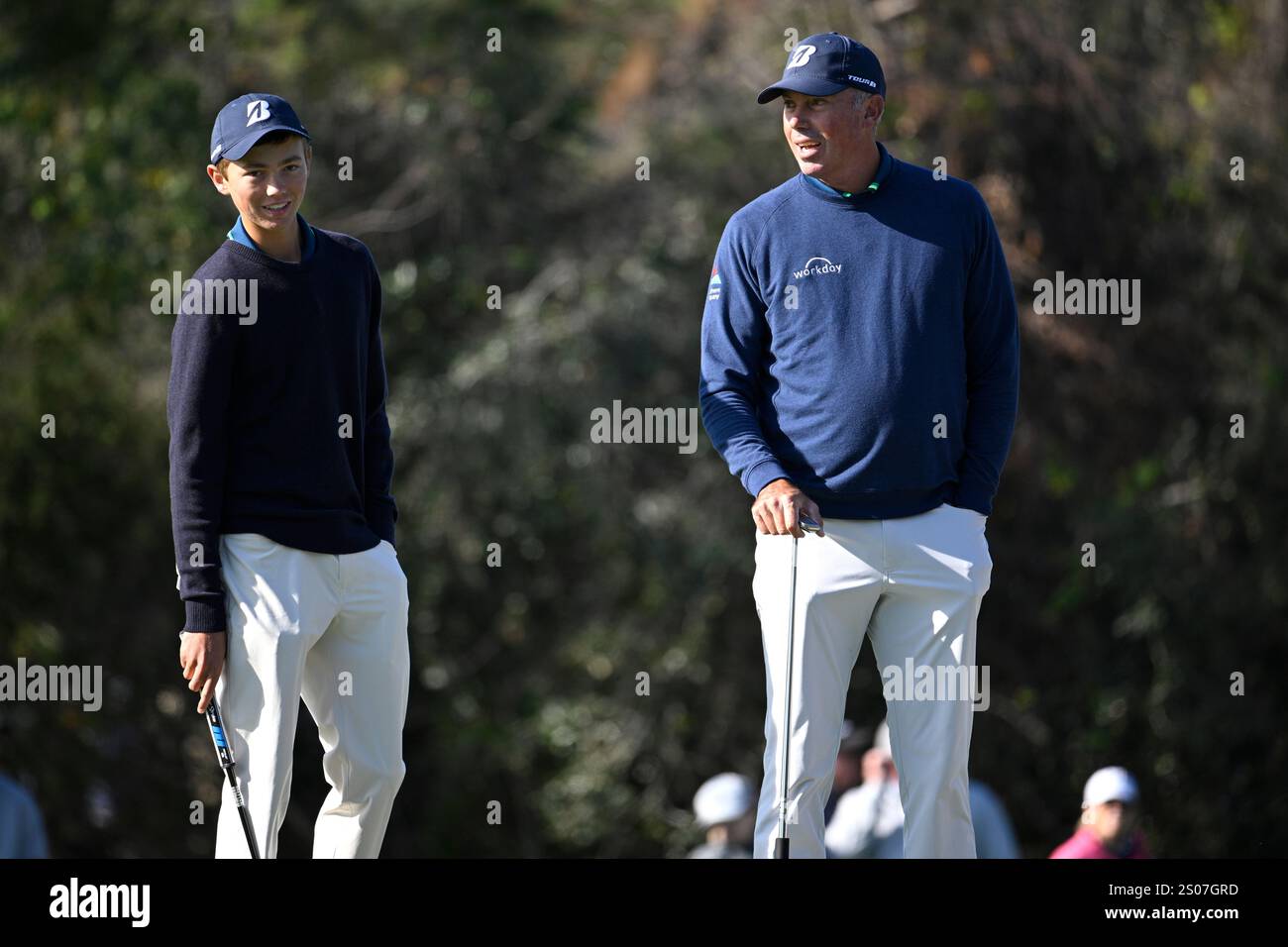 Matt Kuchar, right, chats with his son Carson Kuchar on the third green ...