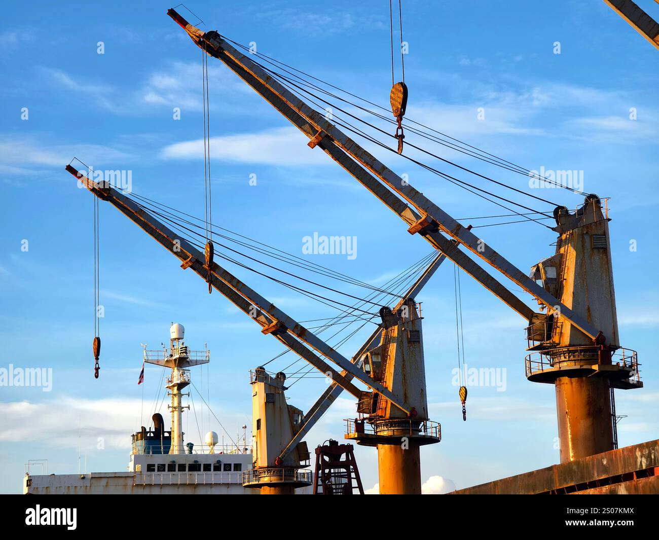 A large ship equipped with cranes mounted on its side Stock Photo - Alamy