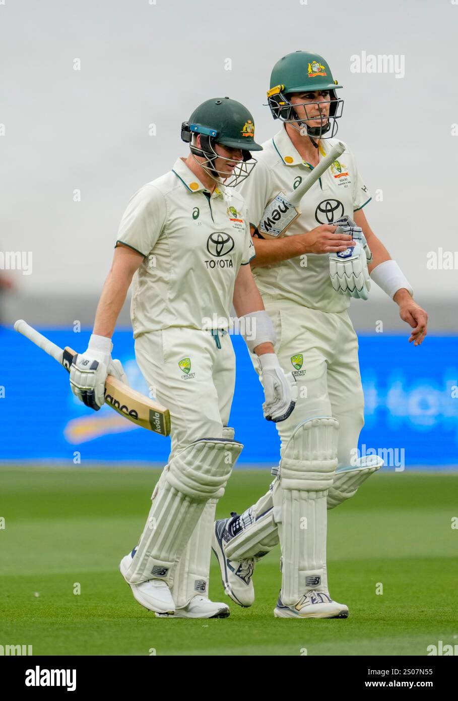 Australia's captain Pat Cummins, right, and Steve Smith, walk off the ...