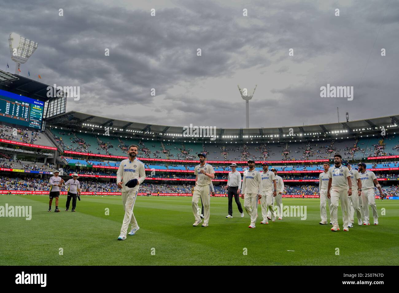 Indian players walk off the field on the end of day one play of the ...