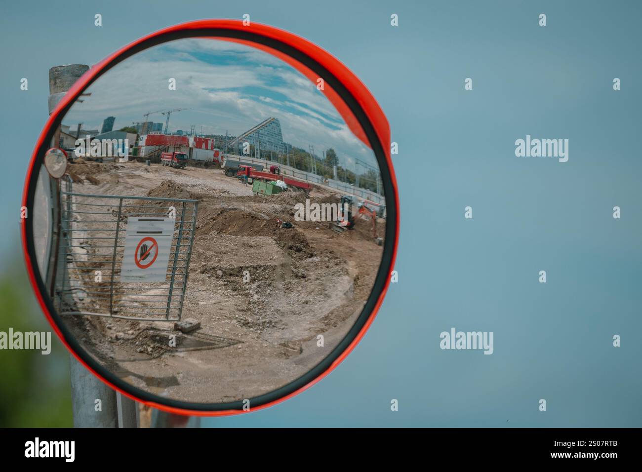 Round traffic mirror mounted high to help drivers view around the blind ...