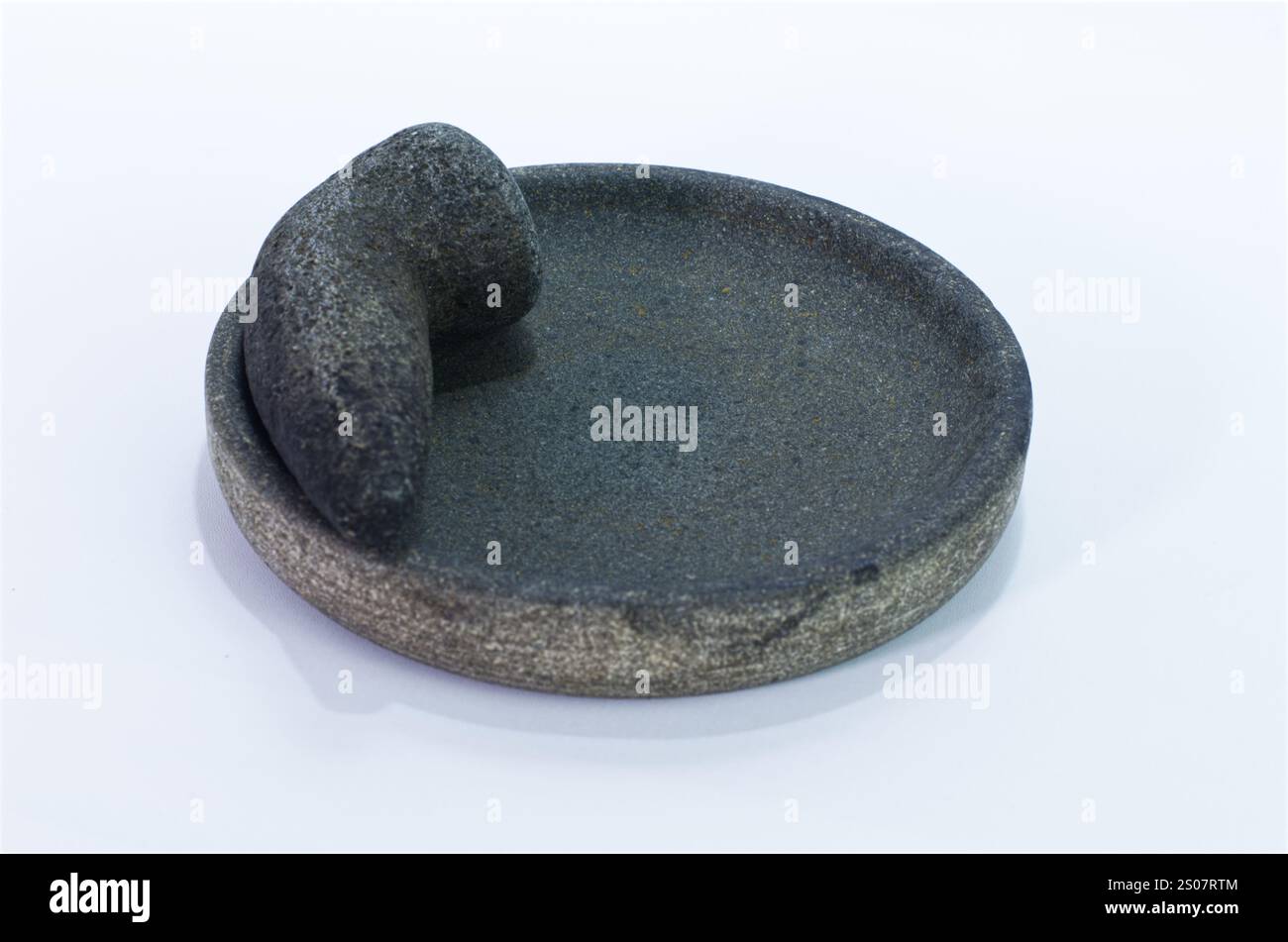 Traditional Stone Mortar and Pestle for Food Preparation on a White ...