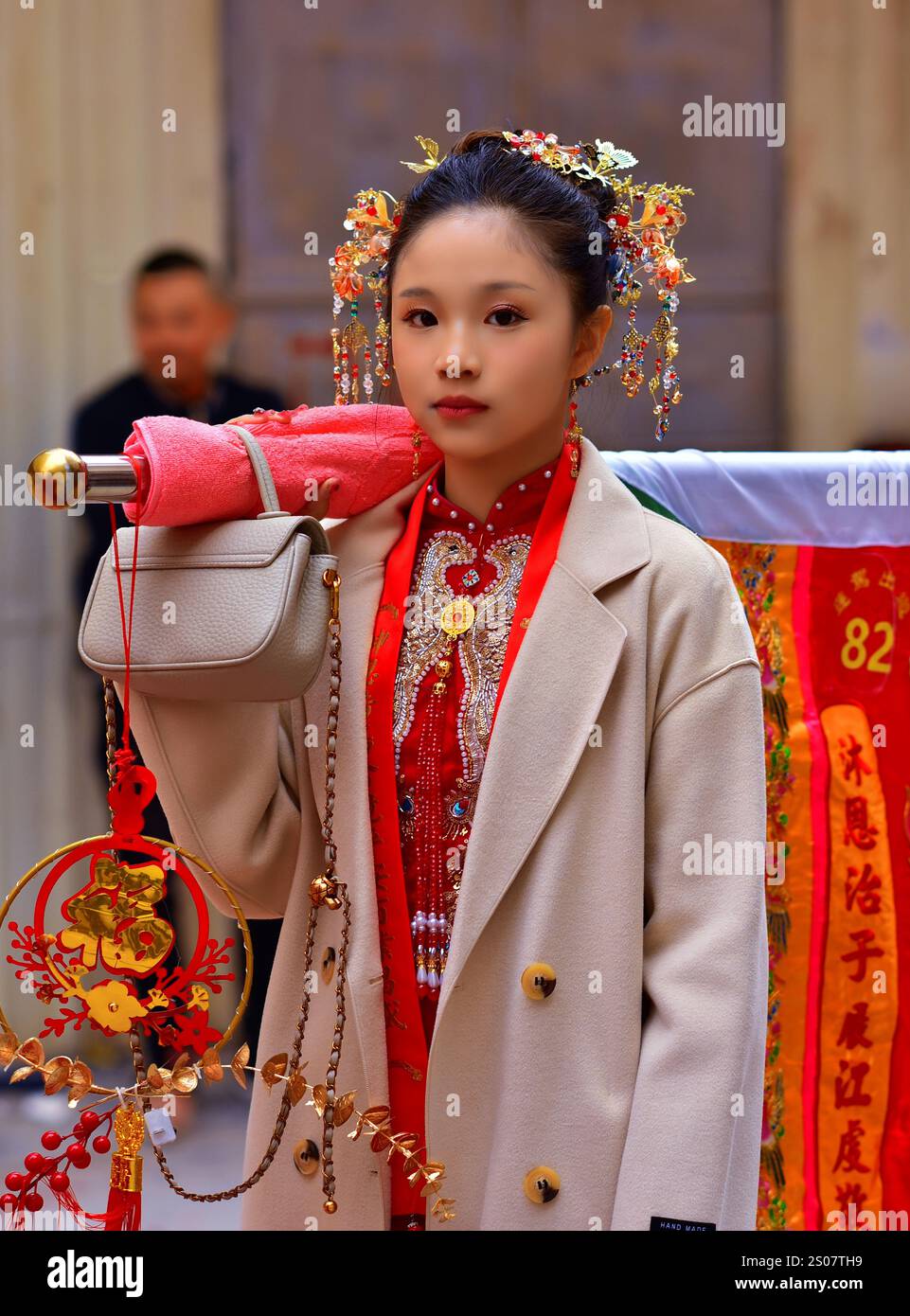 Young women bearing banners in traditional costumes in a colorful ...