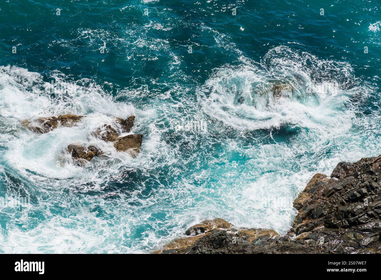 Beautiful sapphire blue ocean washing on the rocks at Bennett Heads ...